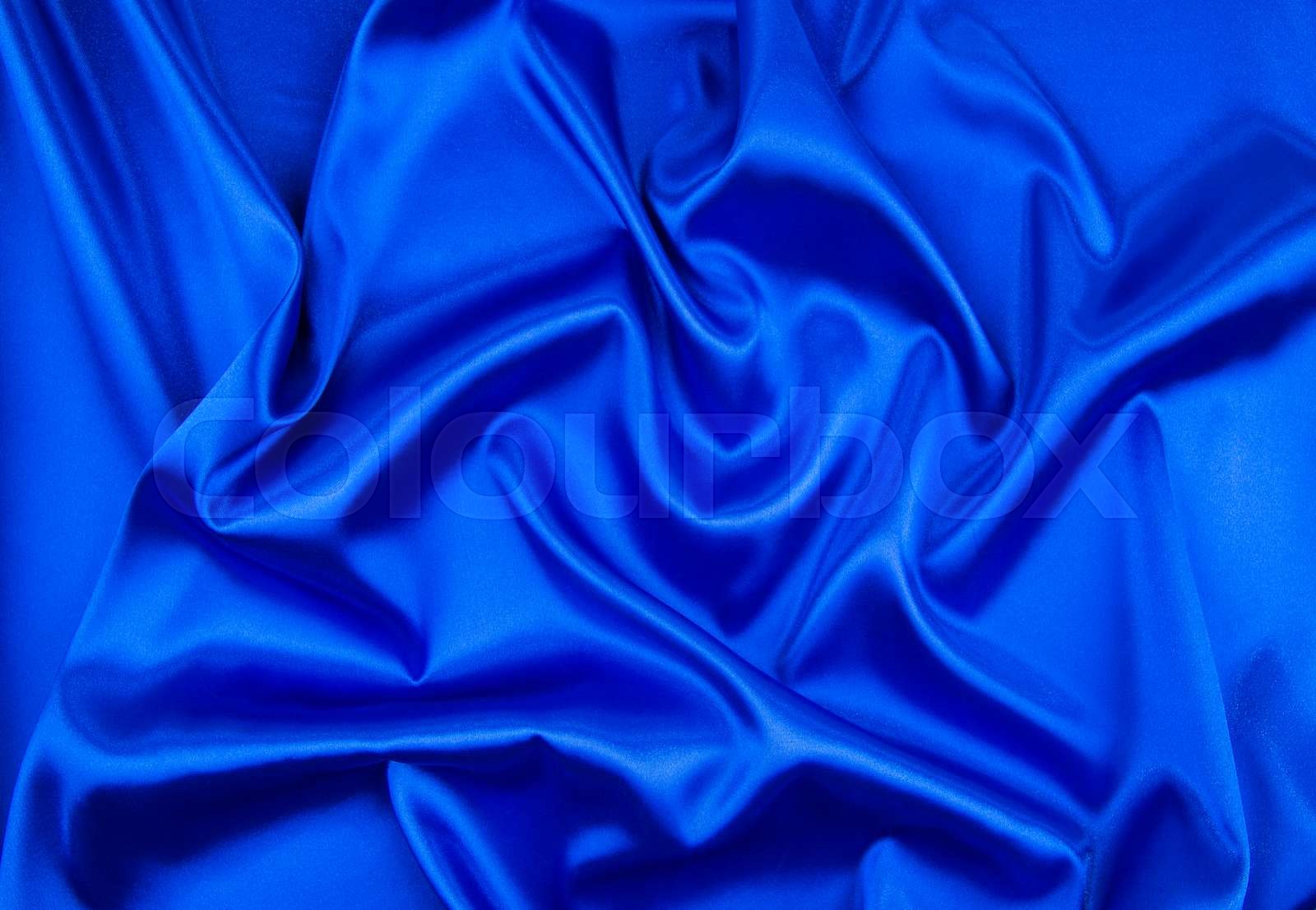 Soft folds of deep blue silk cloth texture. | Stock image | Colourbox