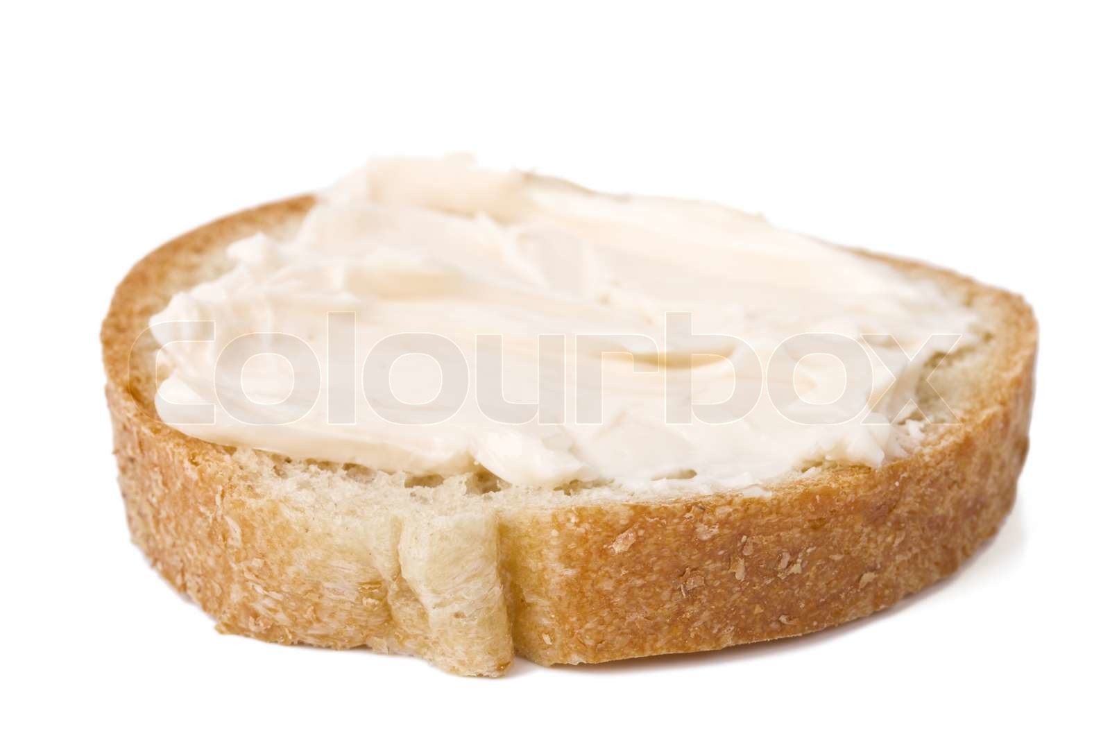 Scheibe Brot mit Käse Creme verteilen darauf | Stock Bild | Colourbox