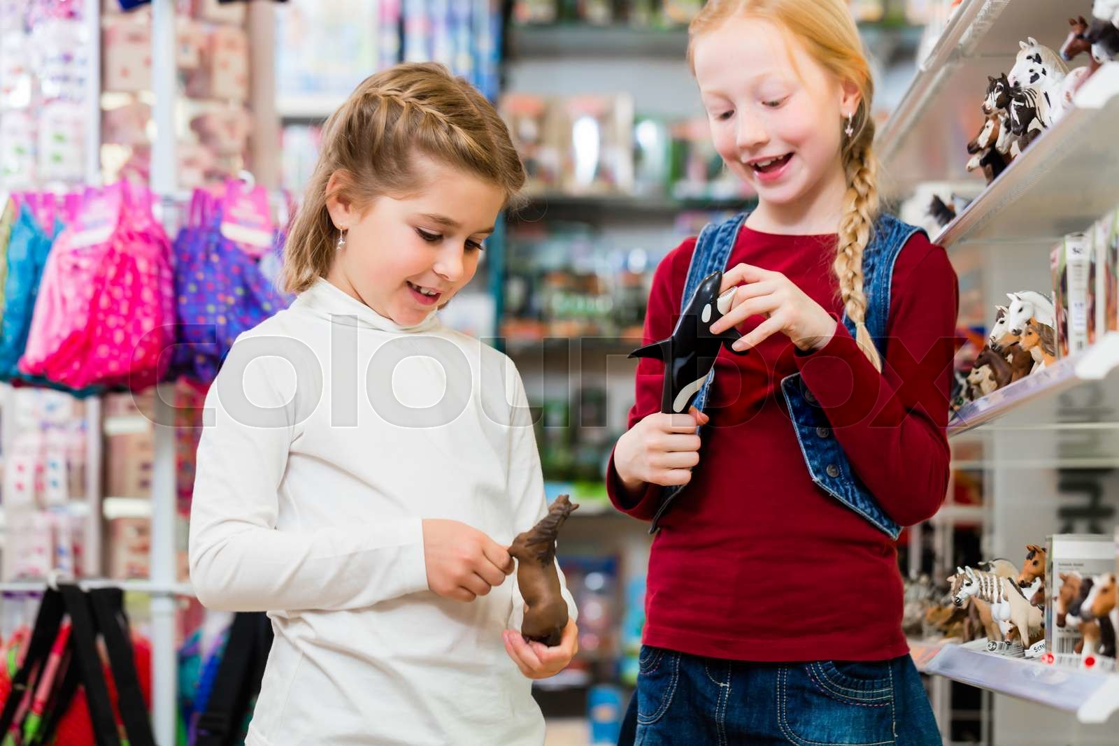 Two kids buying toys in toy store | Stock image | Colourbox