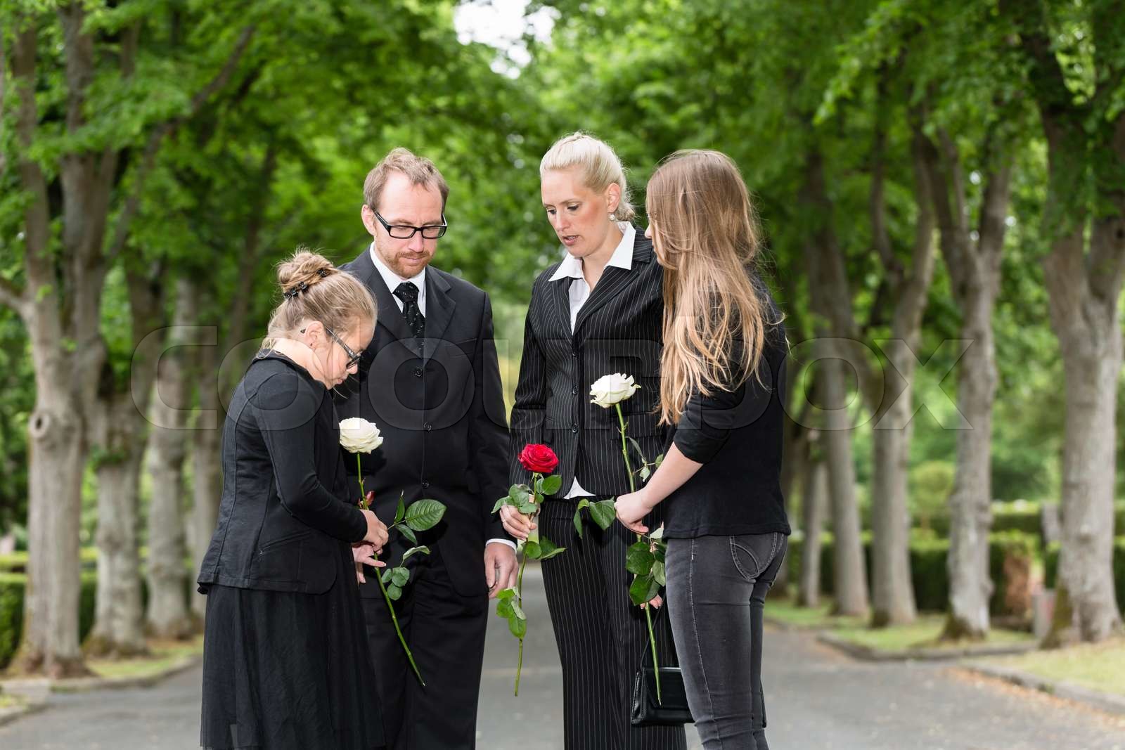 Family mourning on funeral at cemetery | Stock image | Colourbox