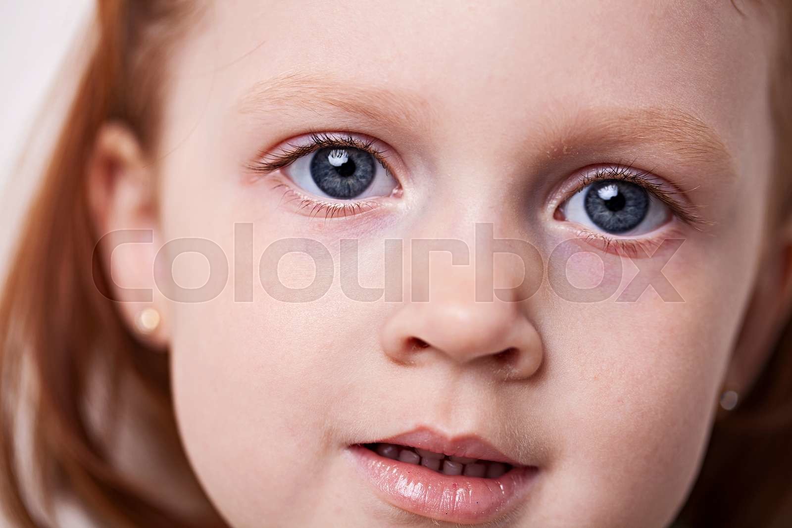 Close up portrait of little ginger girl posing in studio | Stock image ...