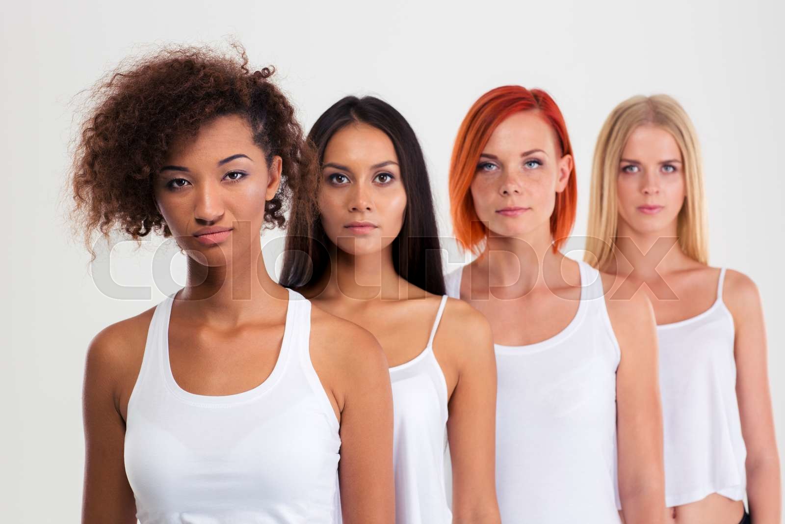 Beautiful four women standing in a row | Stock image | Colourbox