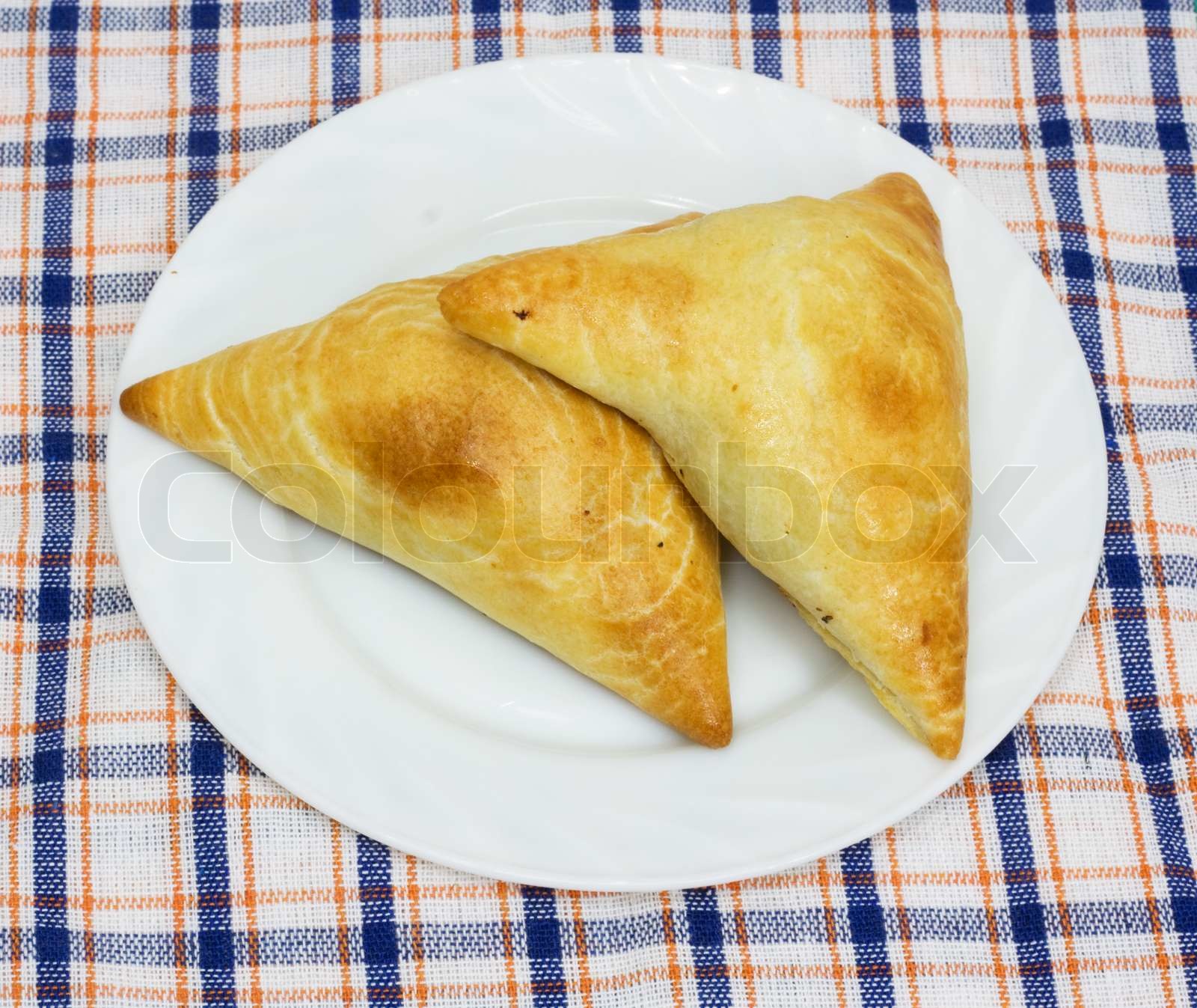 Two traditional South African Samoosa triangles filled with chicken and ...