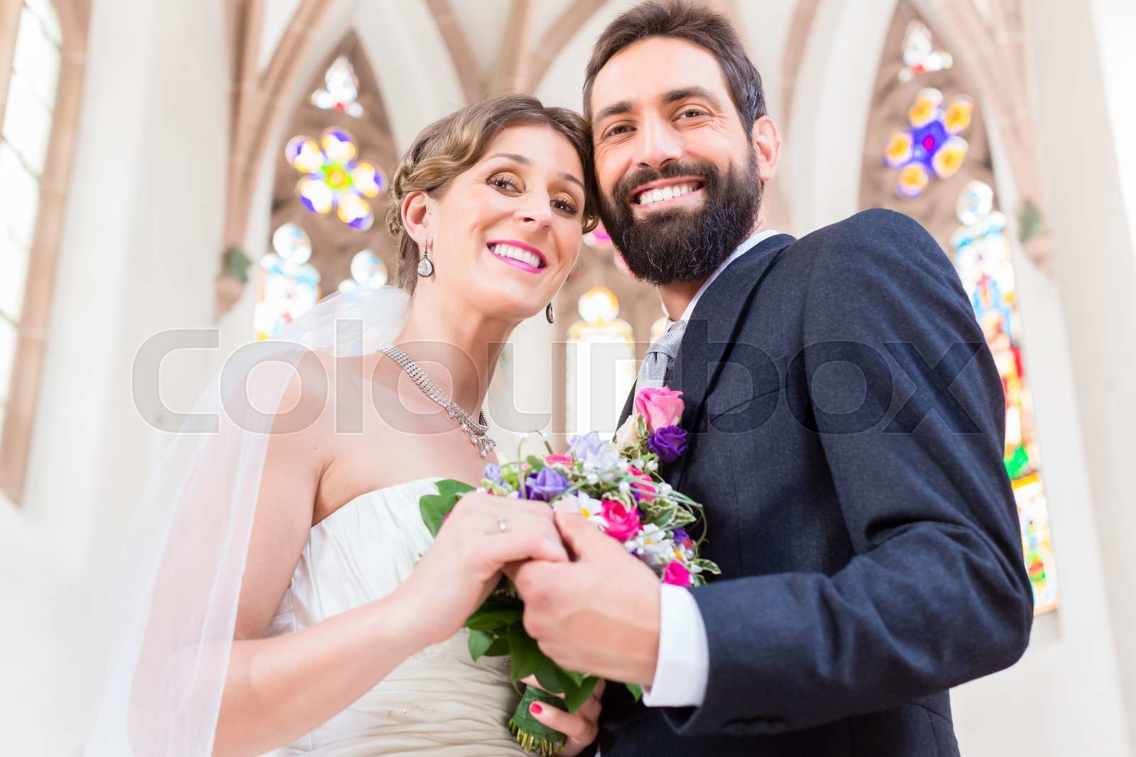 Bridal couple in church having wedding | Stock image | Colourbox