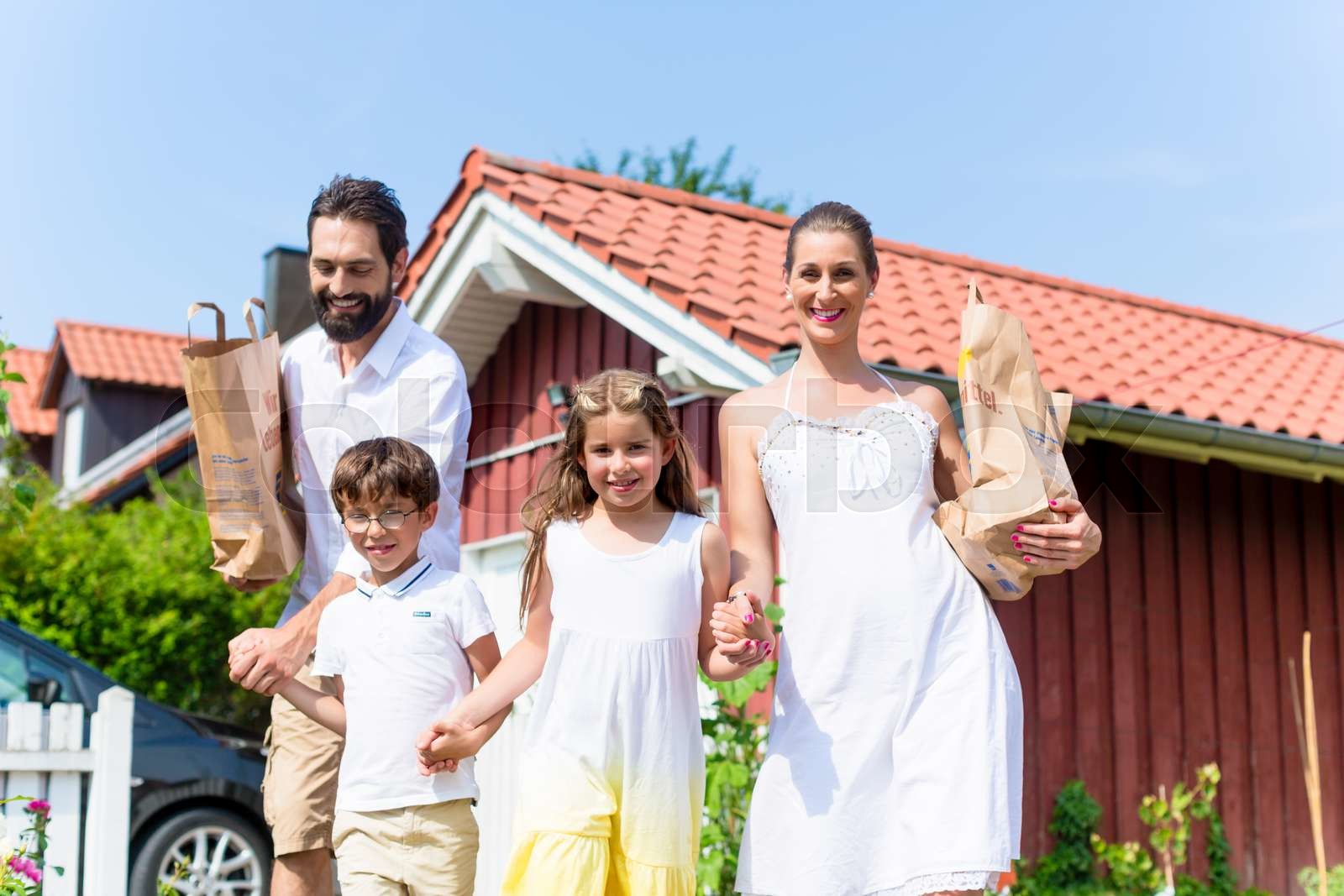 Family coming home from shopping groceries | Stock image | Colourbox