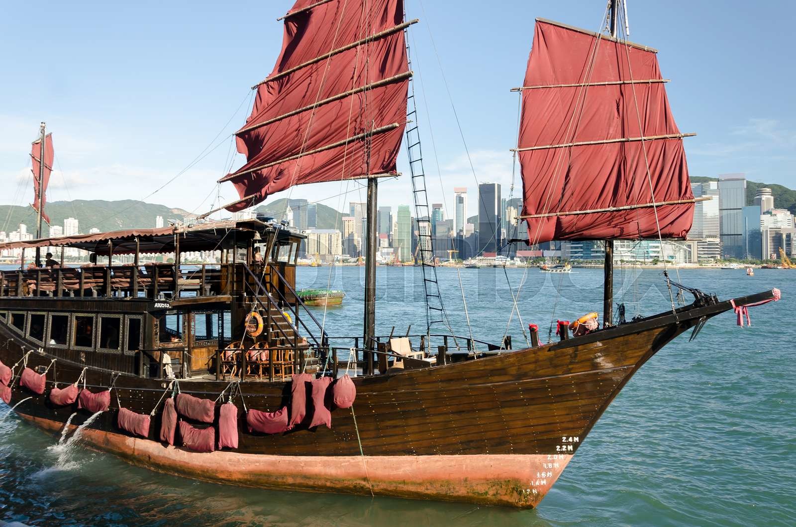 Traditional wooden sailboat / tourist junk sailing in Victoria Harbour ...