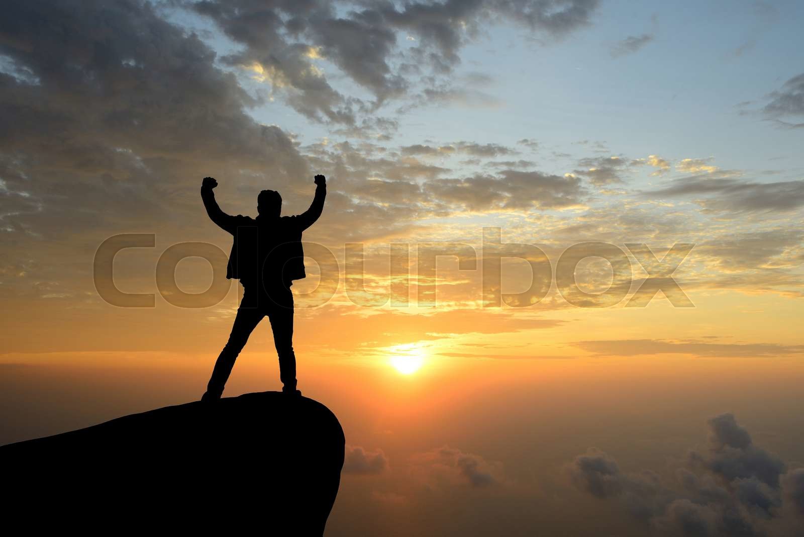 silhouette achievements successful man is on top of hill celebrating ...