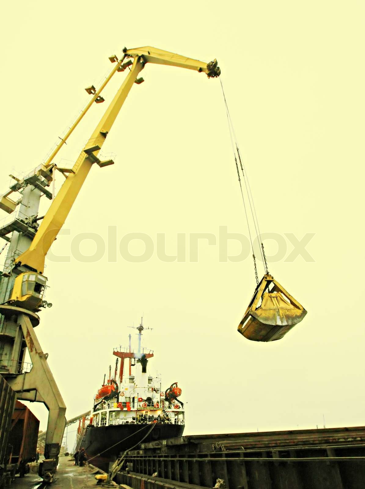 Cargo ship loading on the commercial dock | Stock image | Colourbox