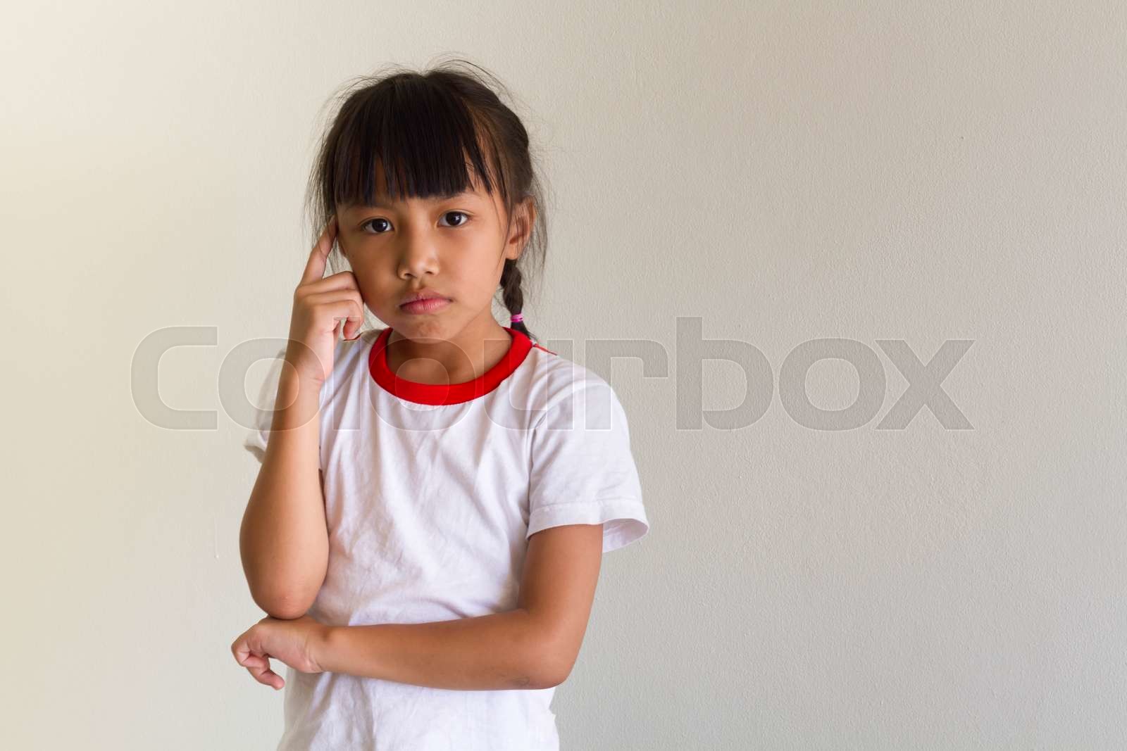 Asian girl kid is thinking for something | Stock image | Colourbox