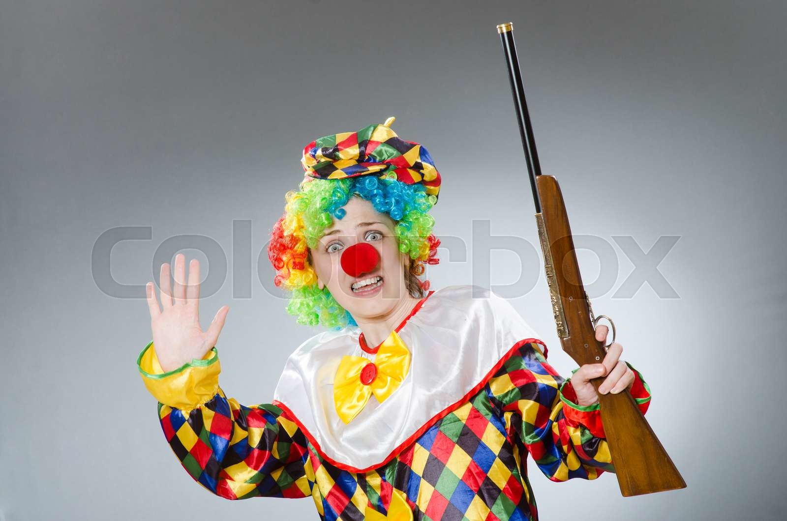 Clown with rifle isolated on white | Stock image | Colourbox