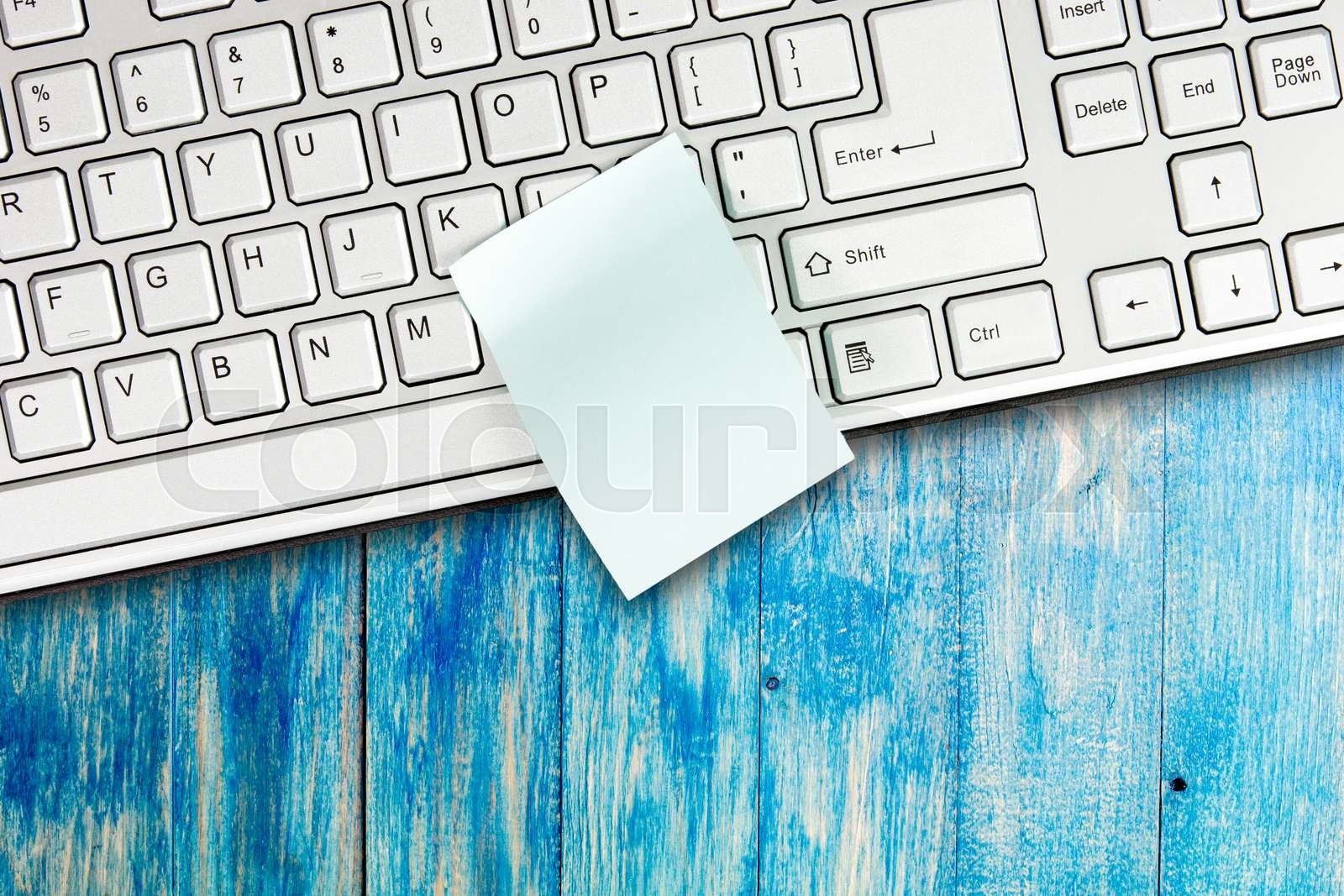Sticky note is on the computer keyboard | Stock image | Colourbox