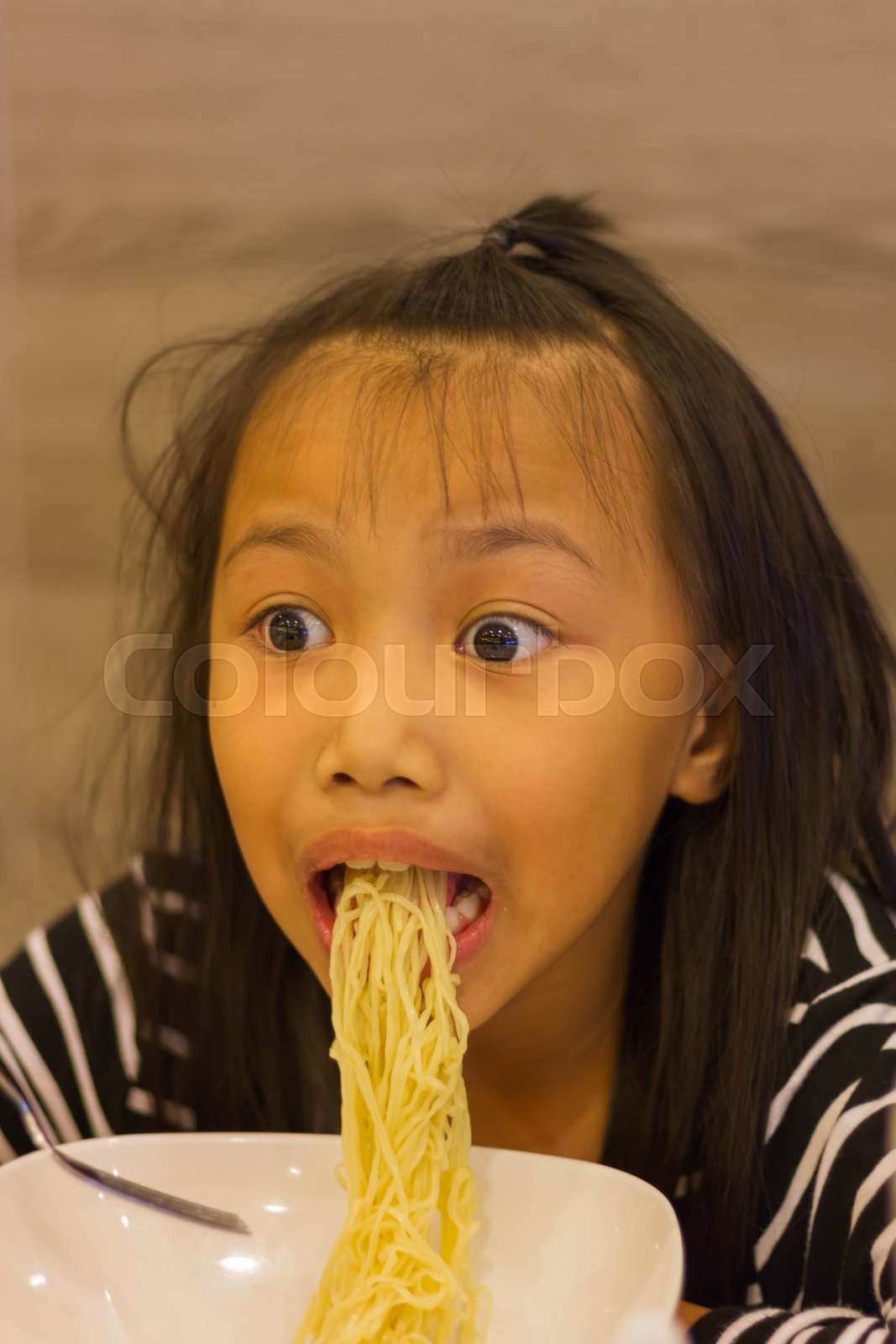 Portrait of Surprised noodles taste little asian kid | Stock image ...