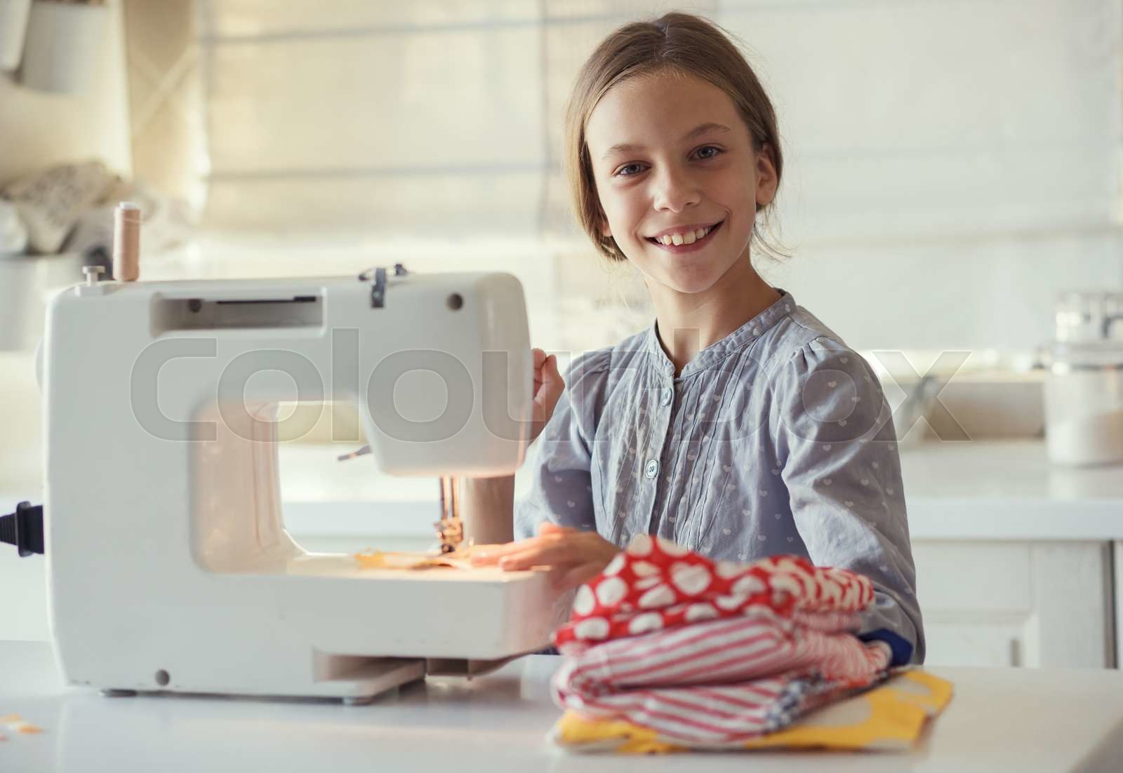 Child sewing | Stock image | Colourbox