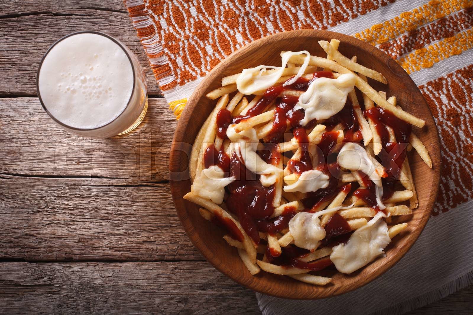 poutine and beer close-up. horizontal top view | Stock image | Colourbox