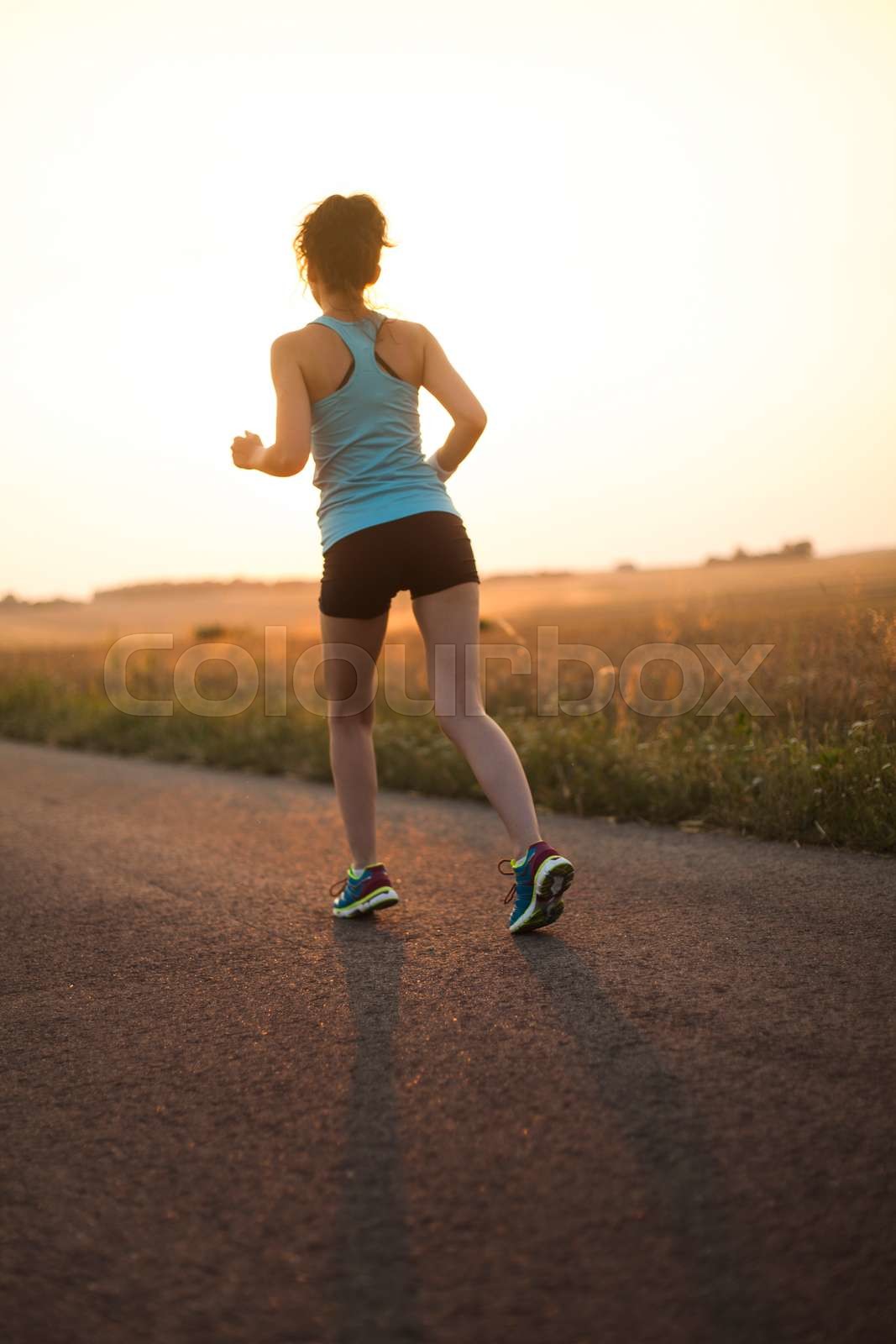 Runner feet running on road closeup on shoe | Stock image | Colourbox