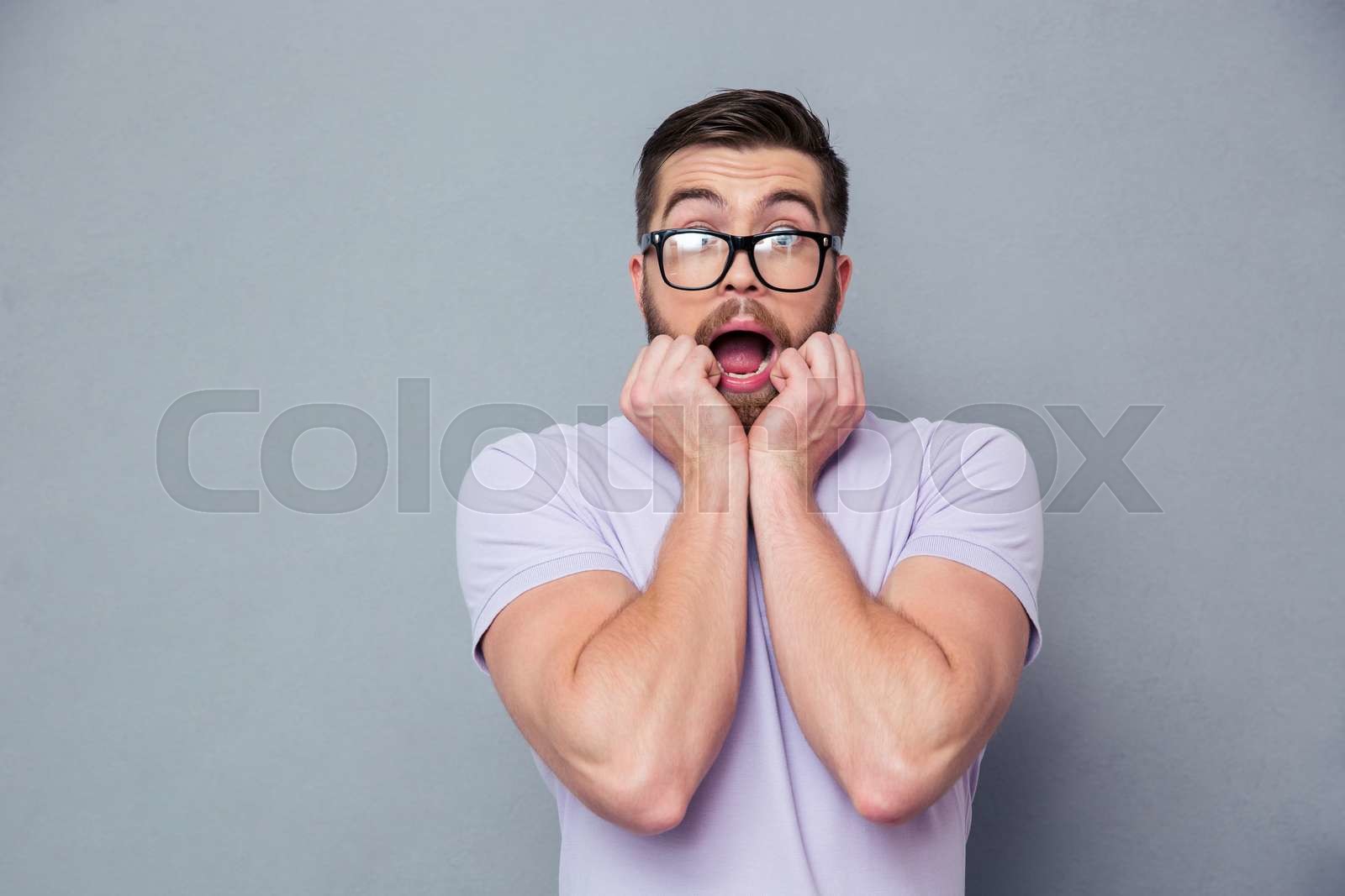Portrait of a scared man looking at camera | Stock image | Colourbox