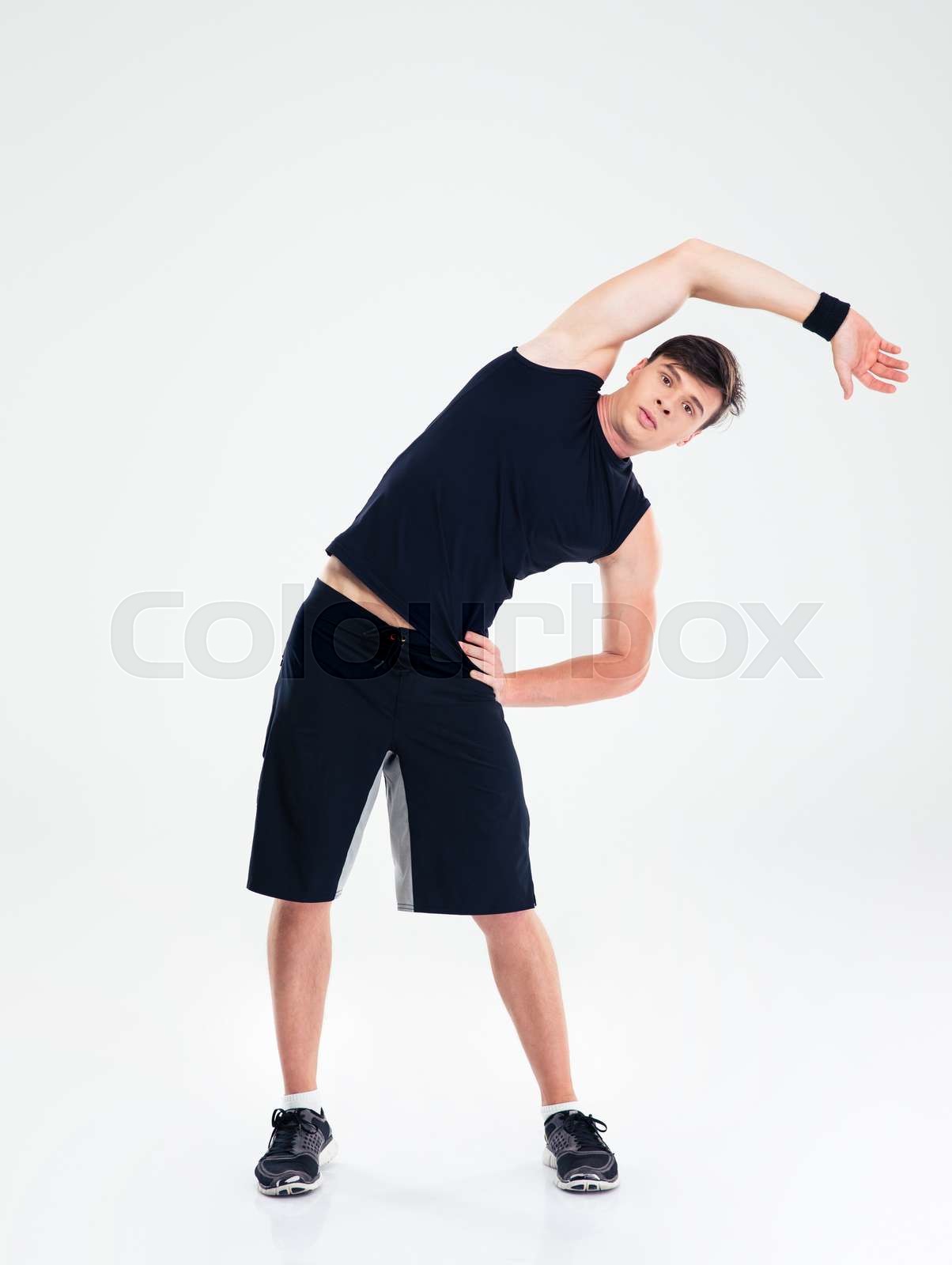 Fitness man doing stretching exercises | Stock image | Colourbox