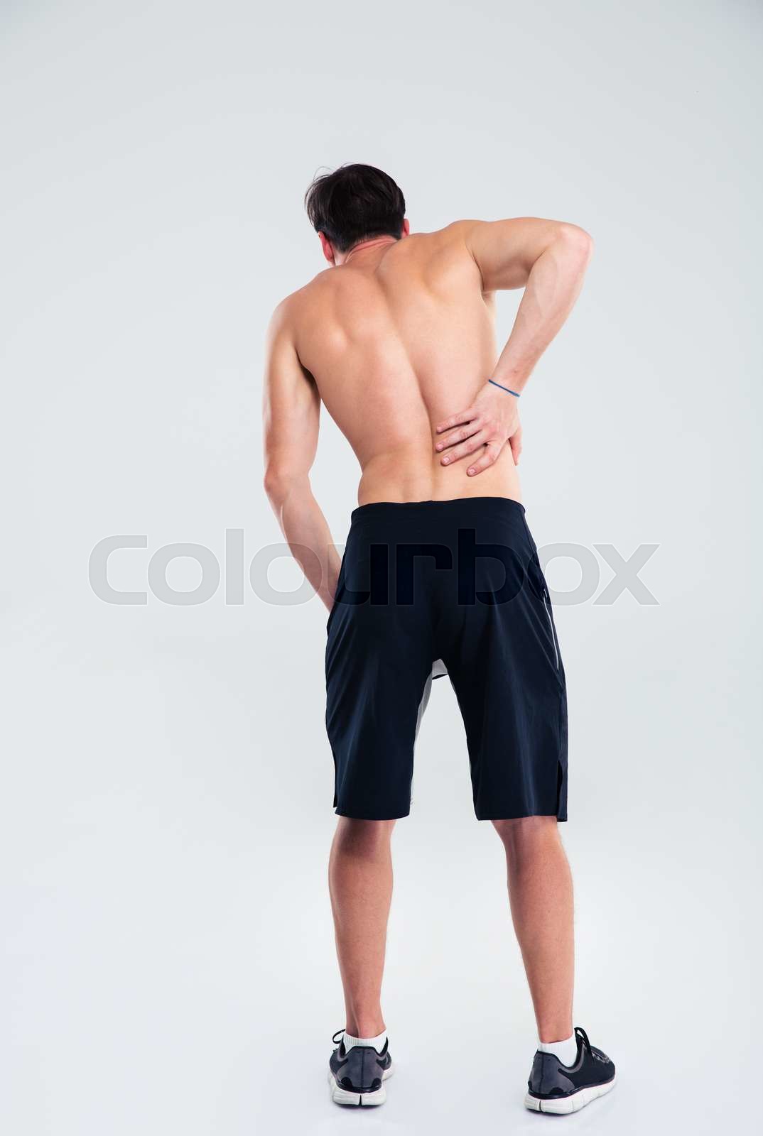 Sports man having back pain | Stock image | Colourbox