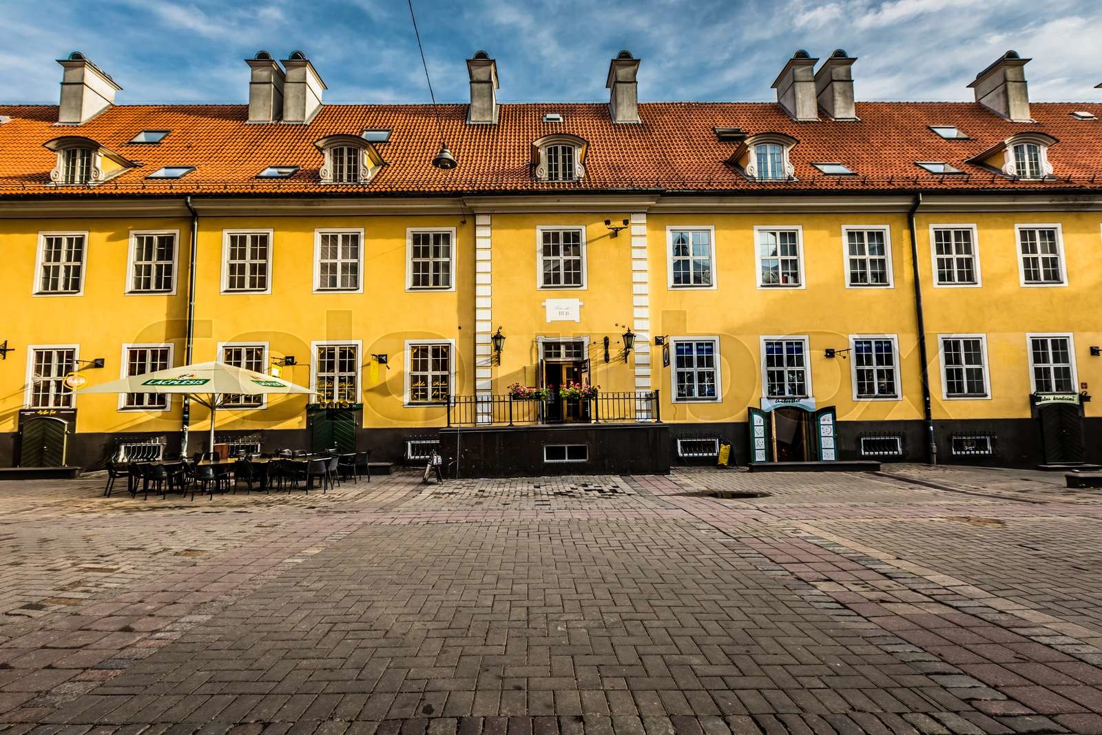 chimneys and red-tiled roofs of the old yellow building in Old Riga ...