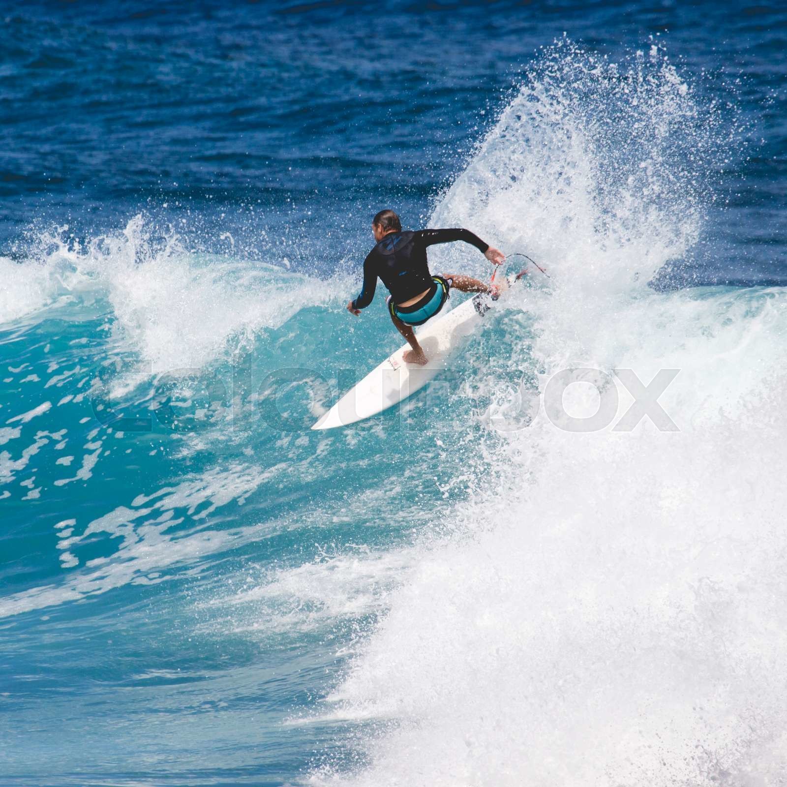 Extreme surfer riding giant ocean wave in Hawaii | Stock image | Colourbox