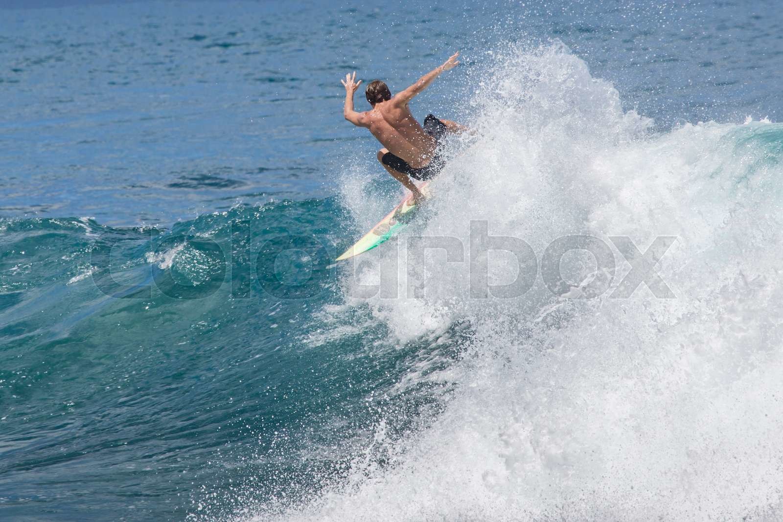 Extreme surfer riding giant ocean wave in Hawaii | Stock image | Colourbox