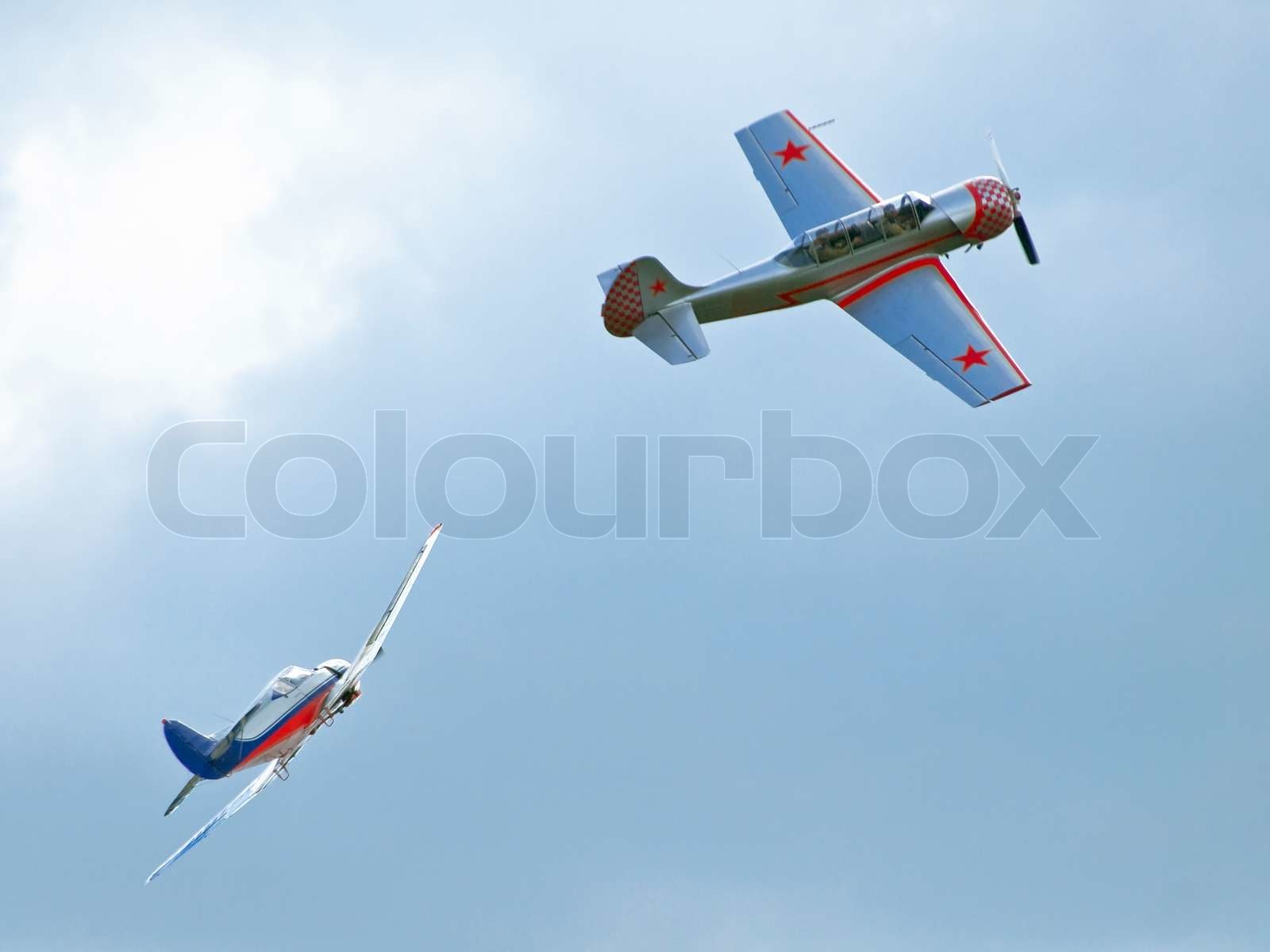 two small airplanes in the cloudy sky | Stock image | Colourbox