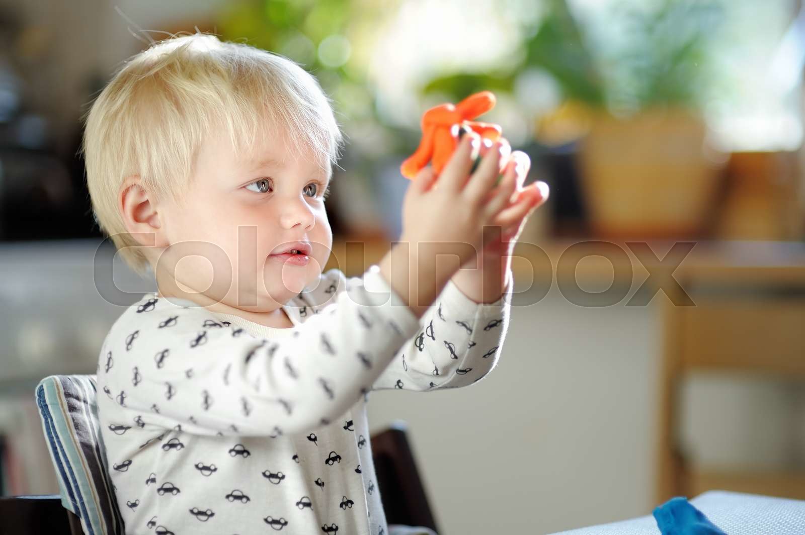 Toddler playing with play dough | Stock image | Colourbox