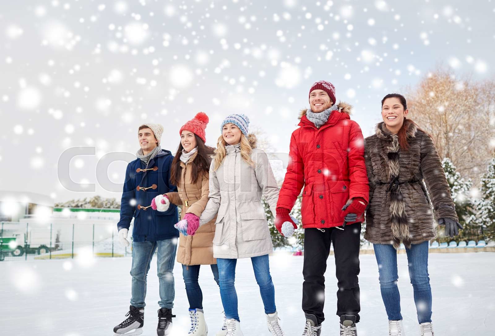 happy friends ice skating on rink outdoors | Stock image | Colourbox