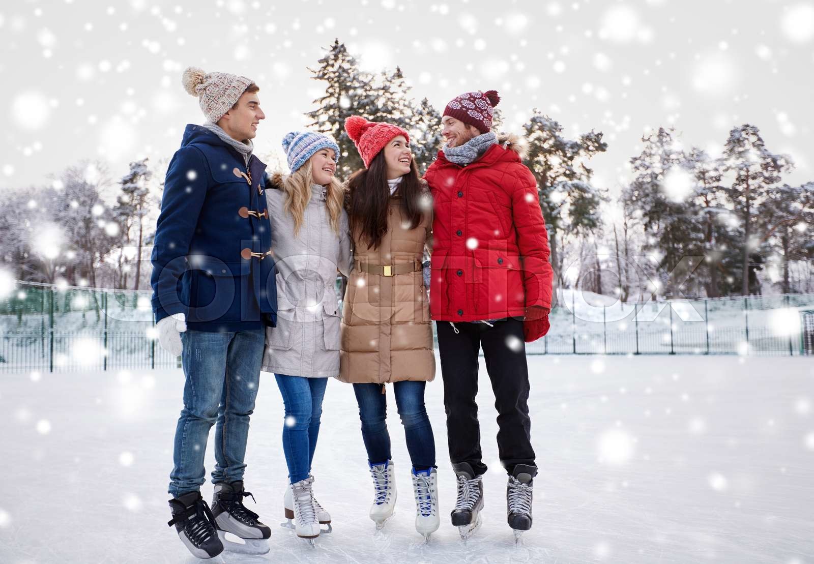 happy friends ice skating on rink outdoors | Stock image | Colourbox