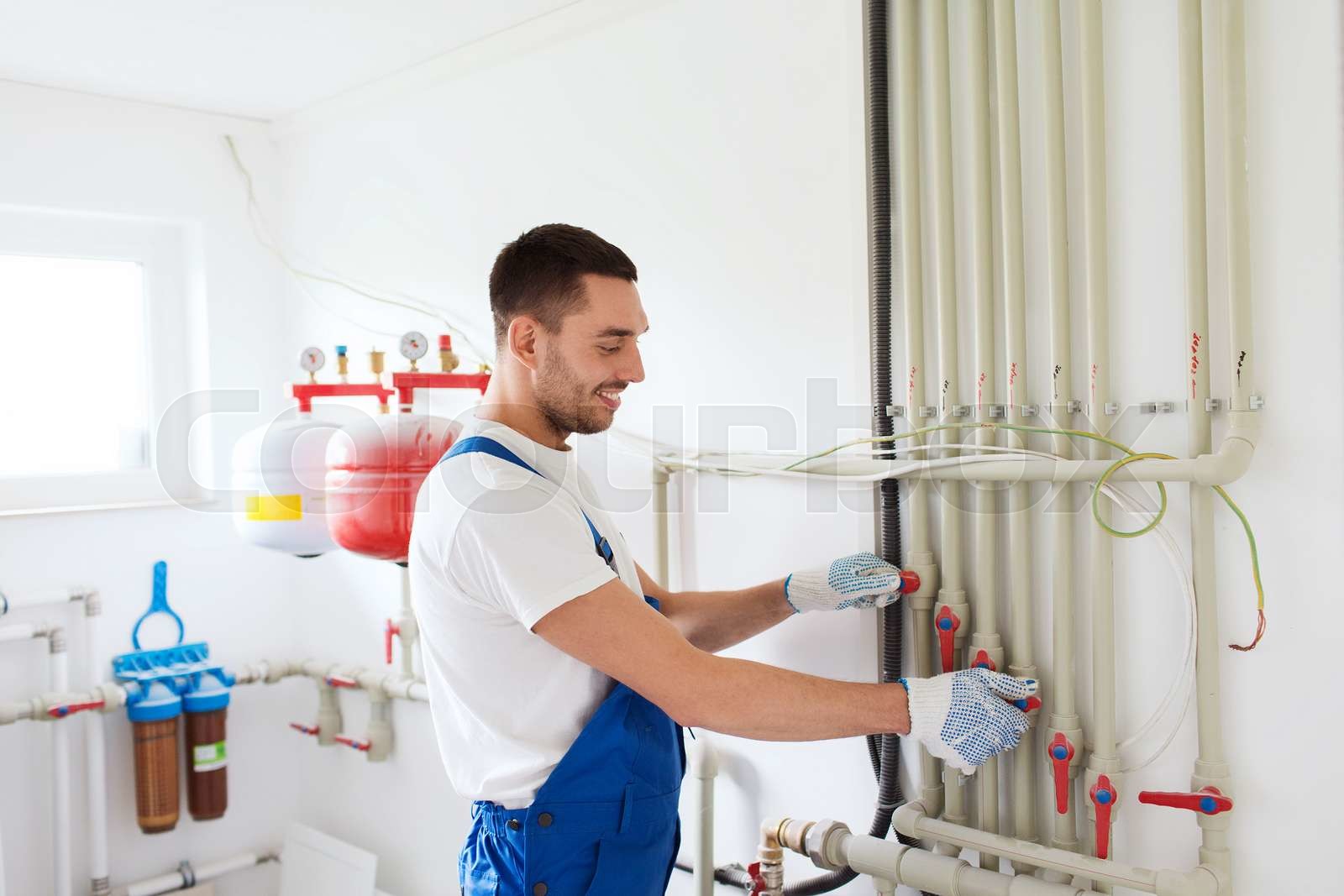 builder or plumber working indoors | Stock image | Colourbox