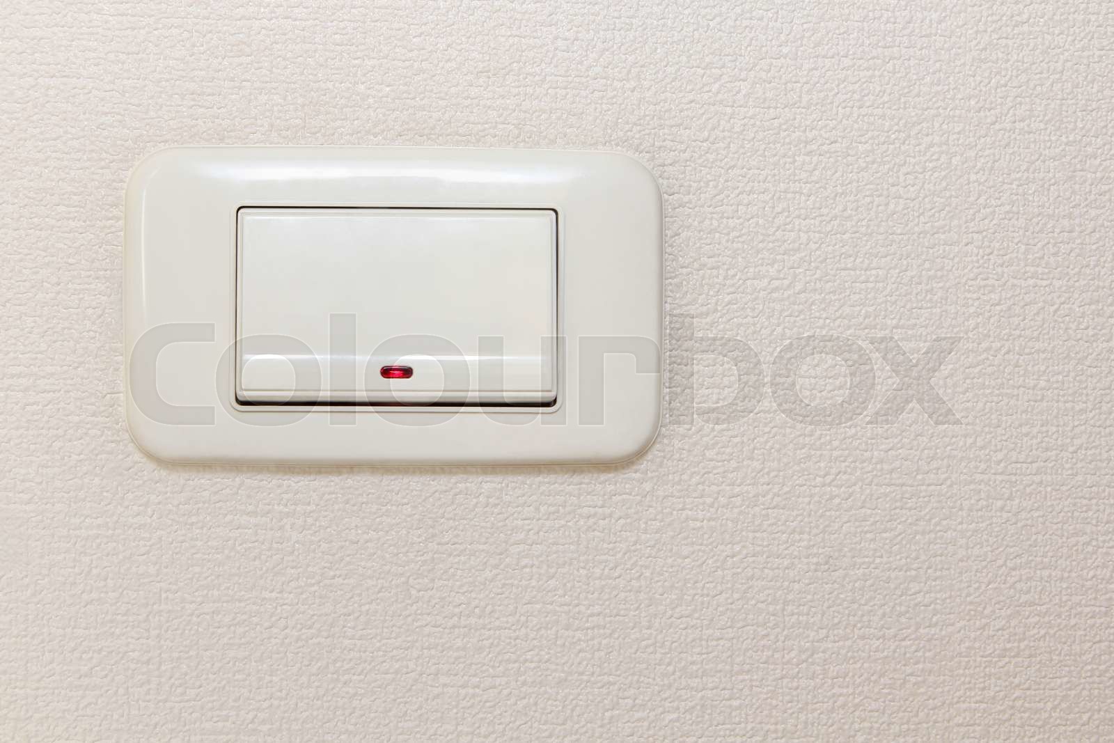 Light switch on beige wall. | Stock image | Colourbox