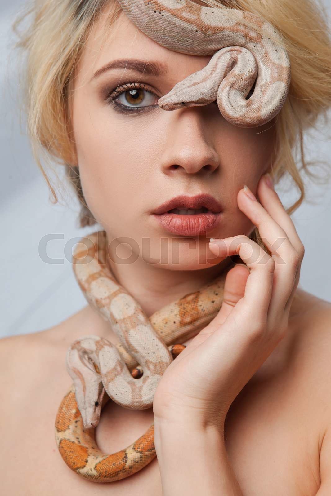 Beautiful girl and the snake Boa constrictors, which wraps around her ...