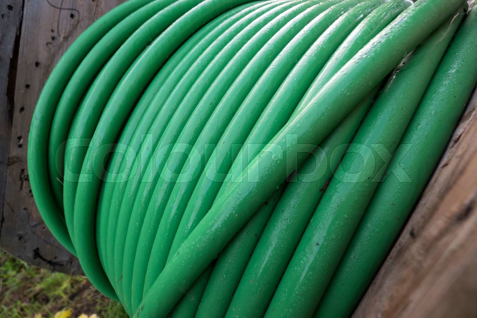 Wooden Coil of Green Electric Cable Outdoor | Stock image | Colourbox