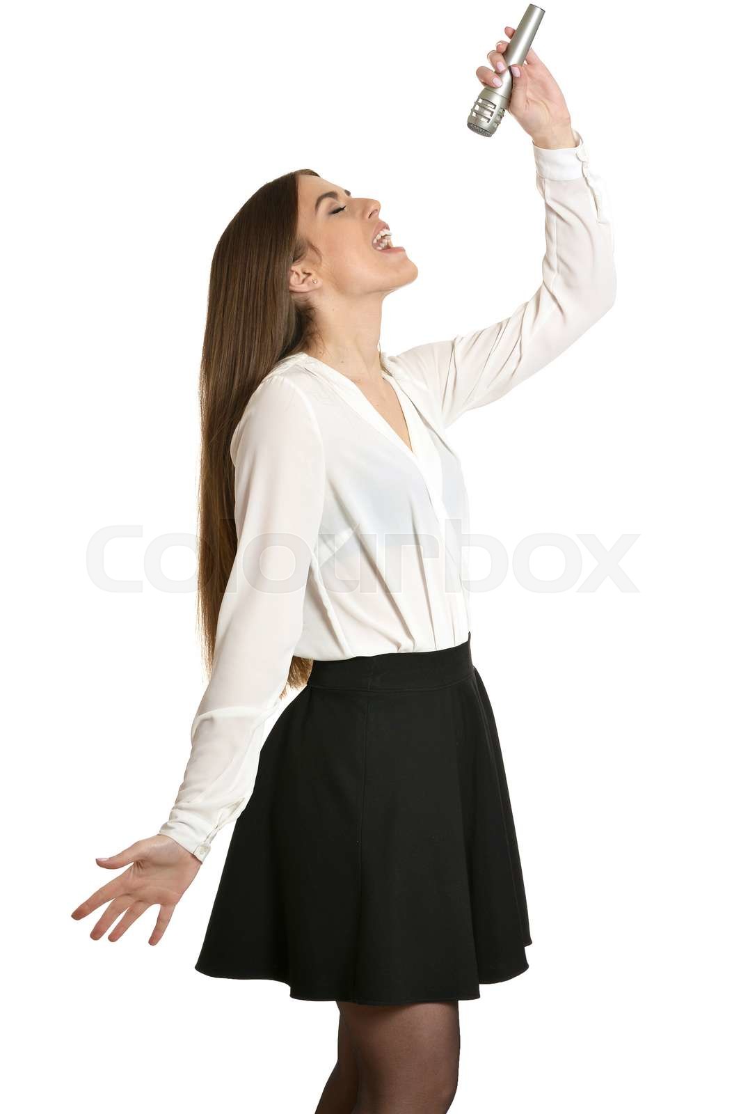 Young woman with microphone | Stock image | Colourbox