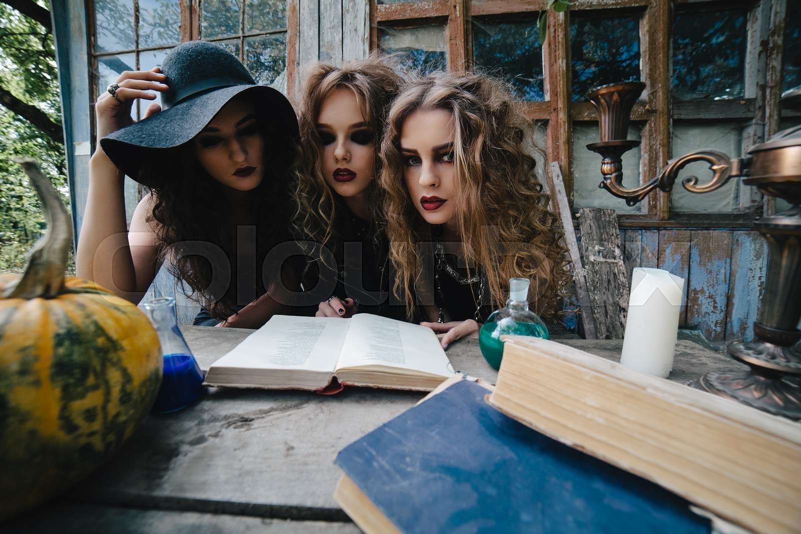 Three vintage witches perform magic ritual | Stock image | Colourbox