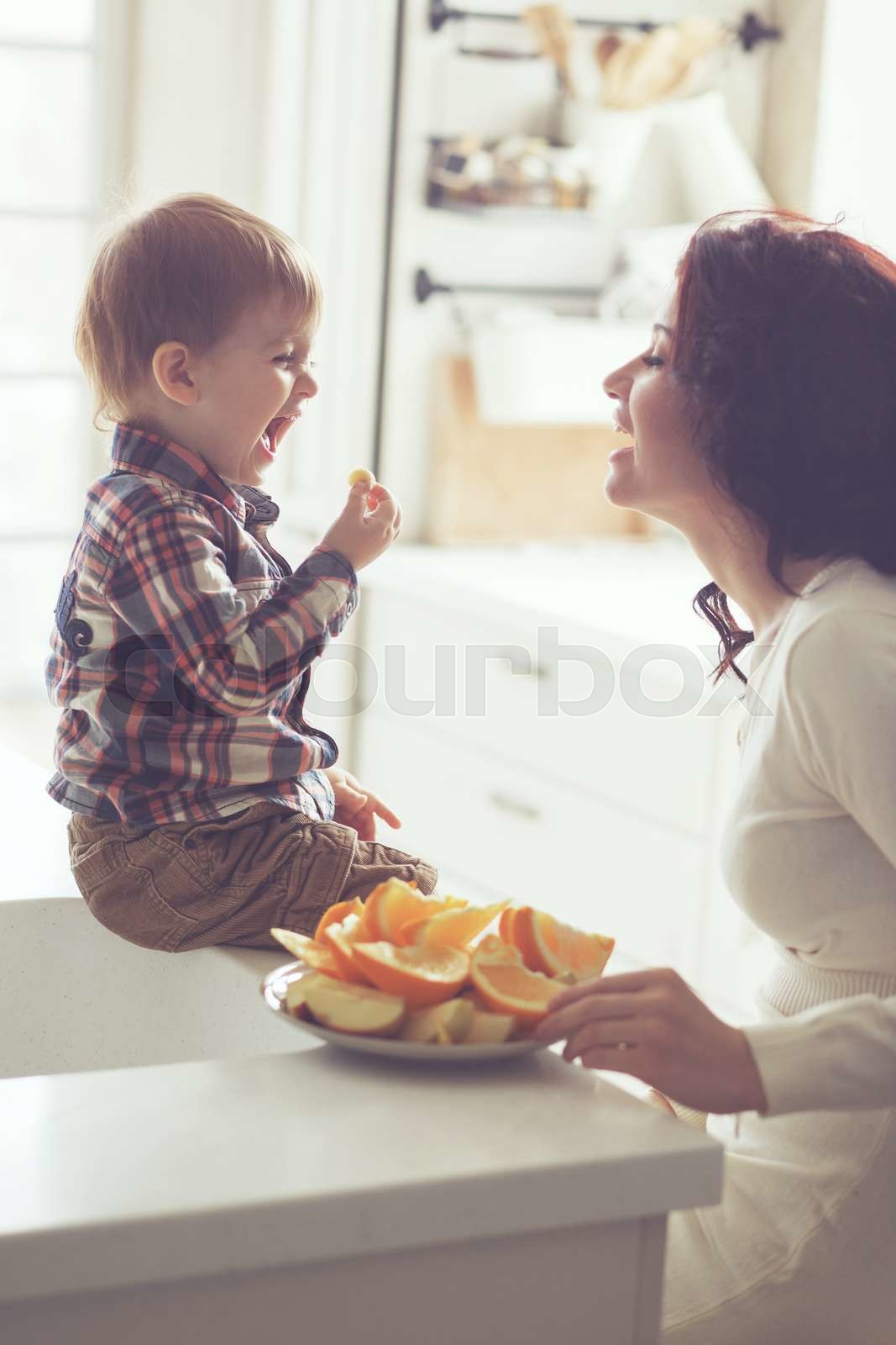Mother and child eating in the kitchen | Stock image | Colourbox