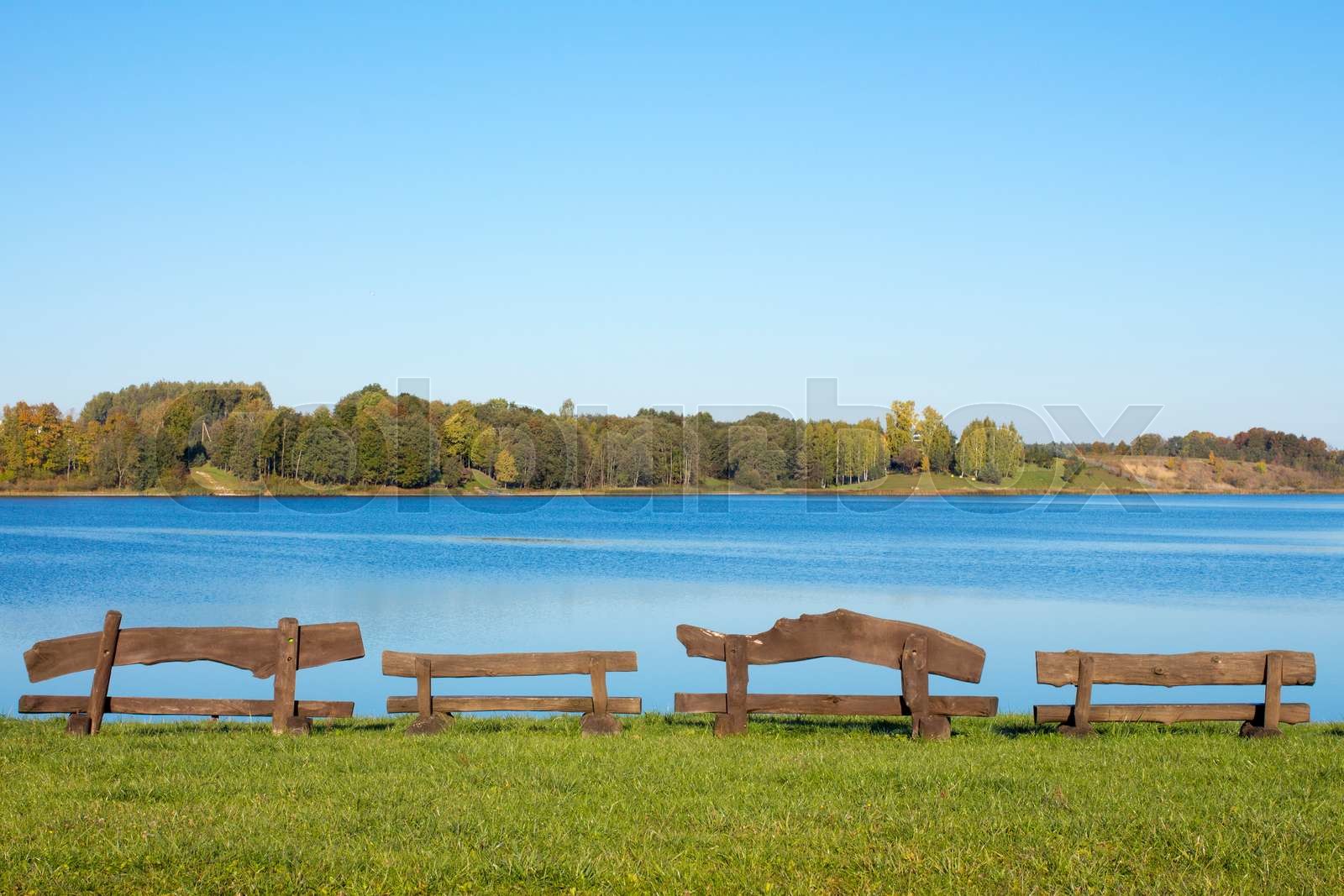 Four wooden benches at the lake | Stock image | Colourbox