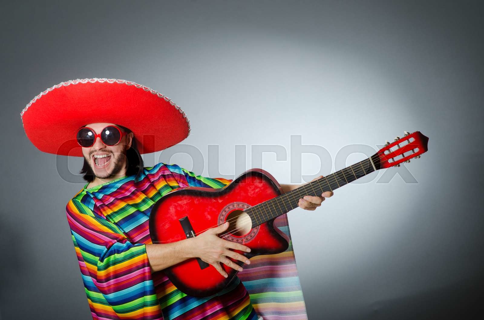 Mexican playing guitar wearing sombrero | Stock image | Colourbox