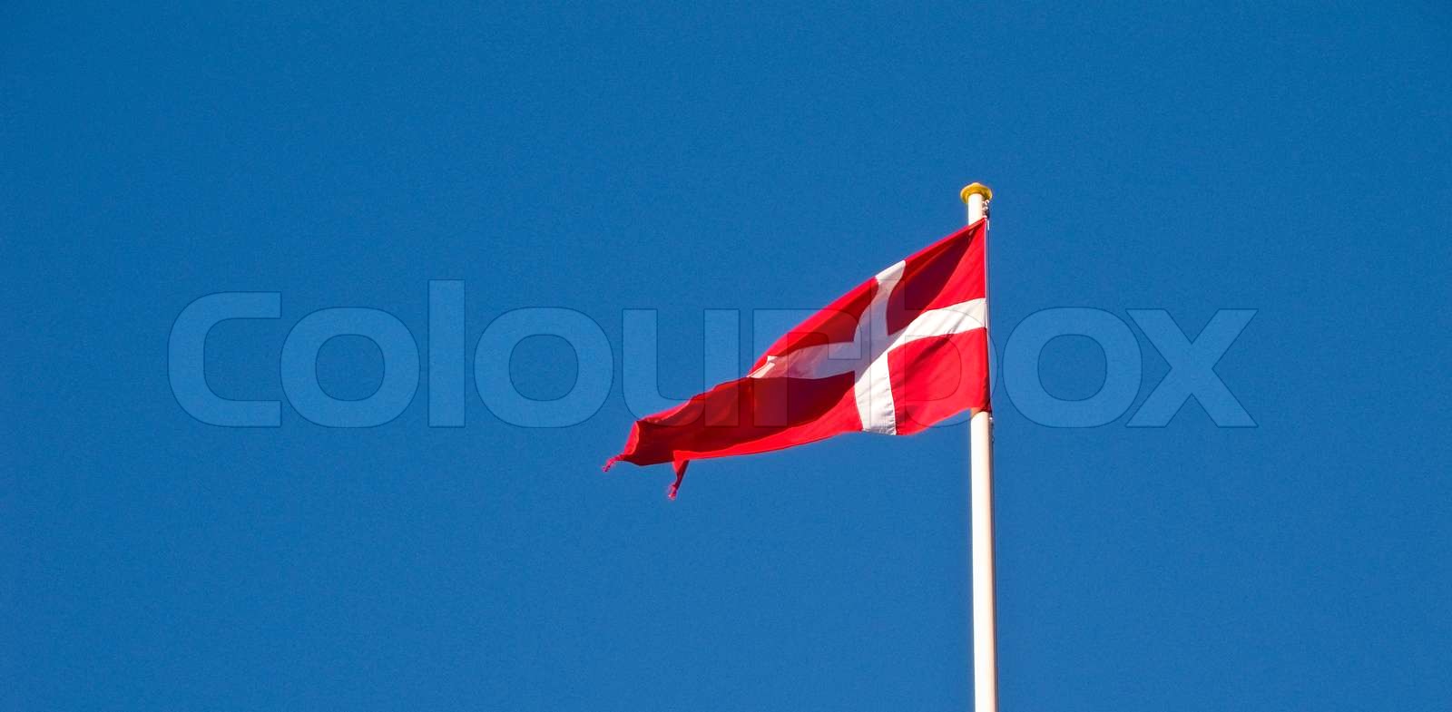 Dansih flag in the wind, dannebrog, against blue sky | Stock image ...