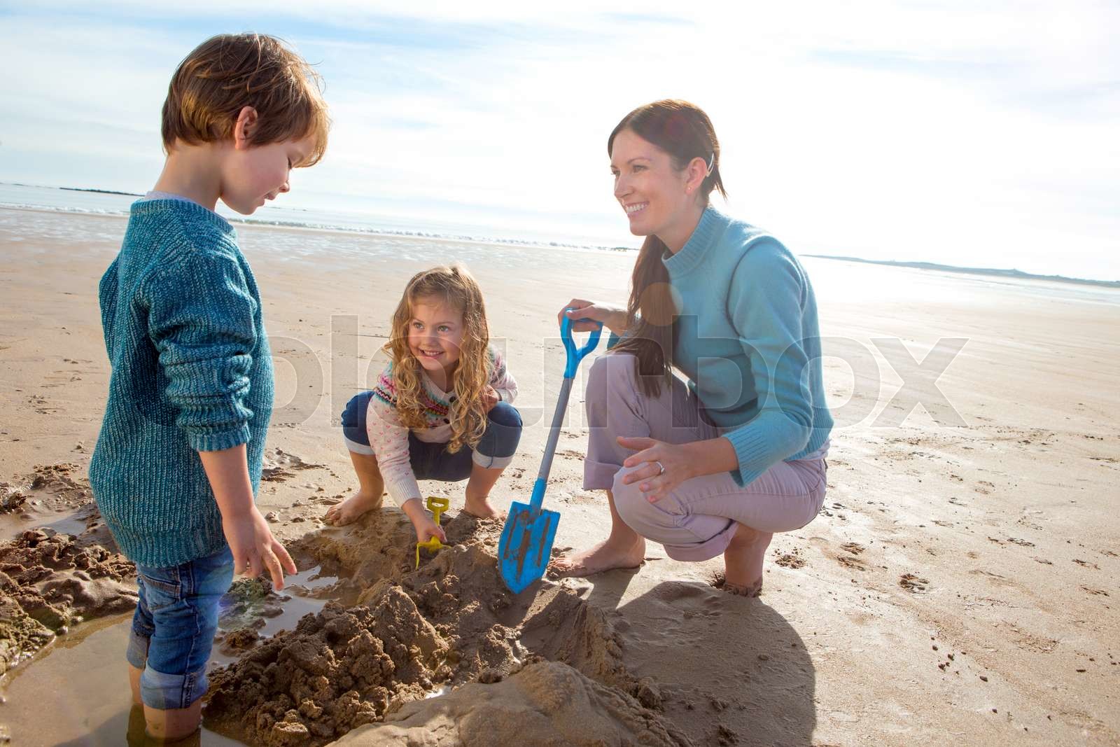 Mother and Children on Beach Digging | Stock image | Colourbox