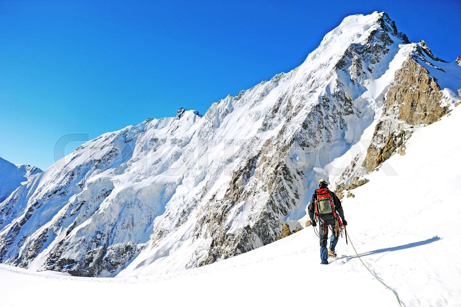 A climber reaching the summit | Stock image | Colourbox