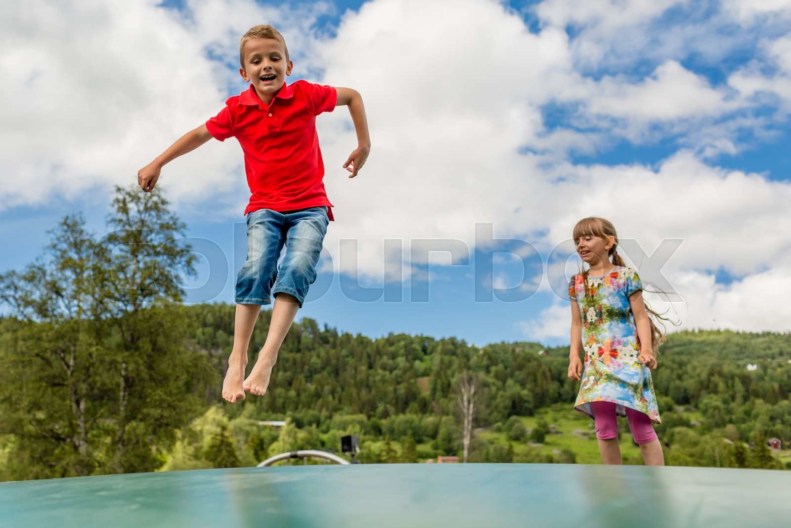 Children bouncing up and down on trampoline | Stock image | Colourbox