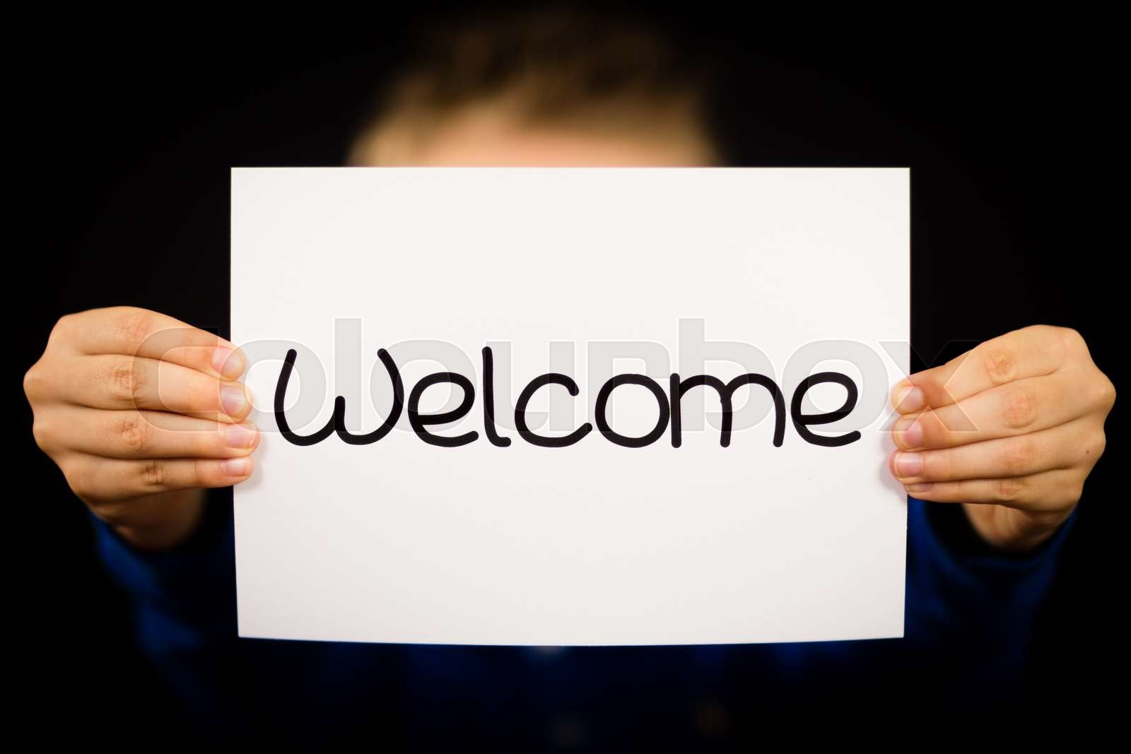 Child holding Welcome sign | Stock image | Colourbox
