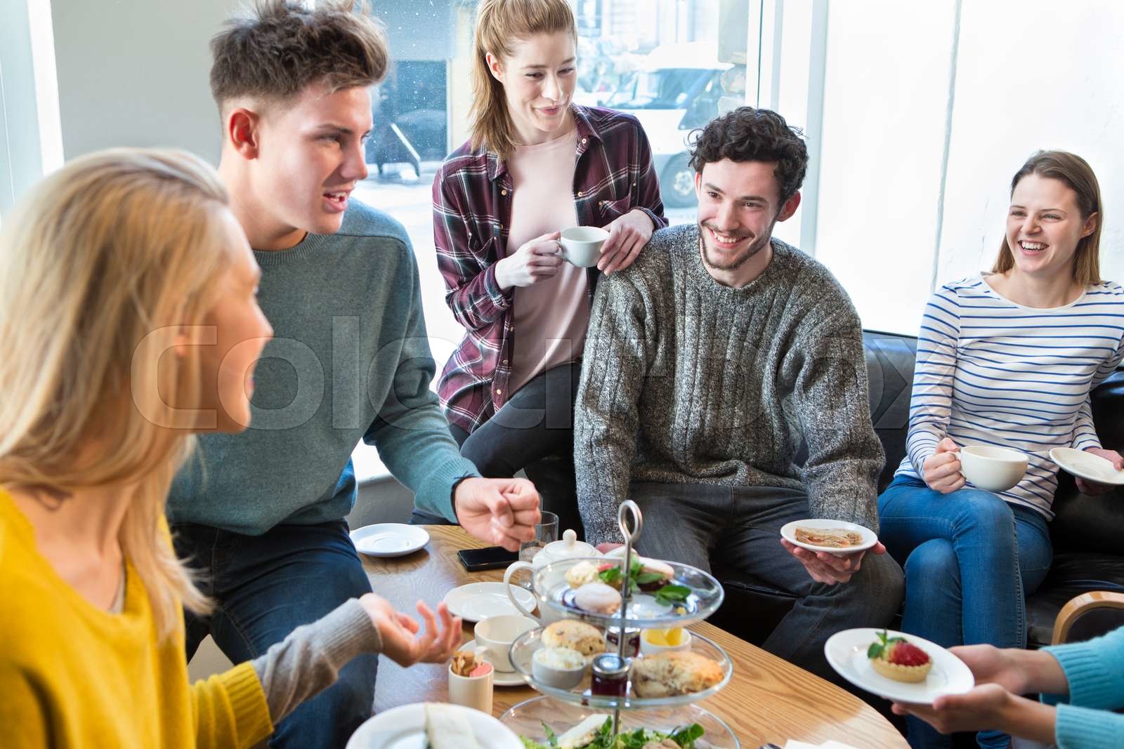 Friends having afternoon tea in a cafe | Stock image | Colourbox