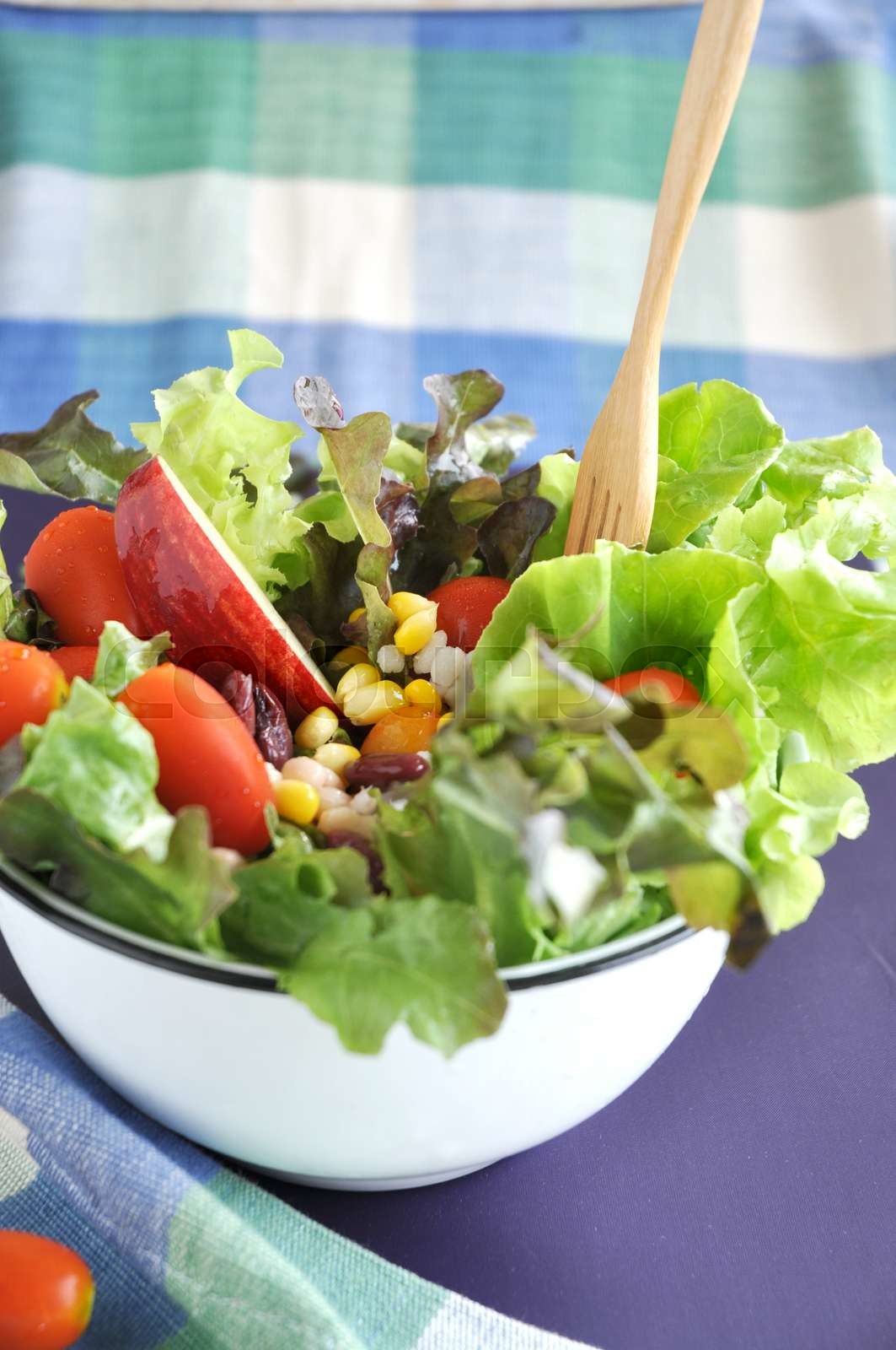 wooden fork on fresh salad | Stock image | Colourbox