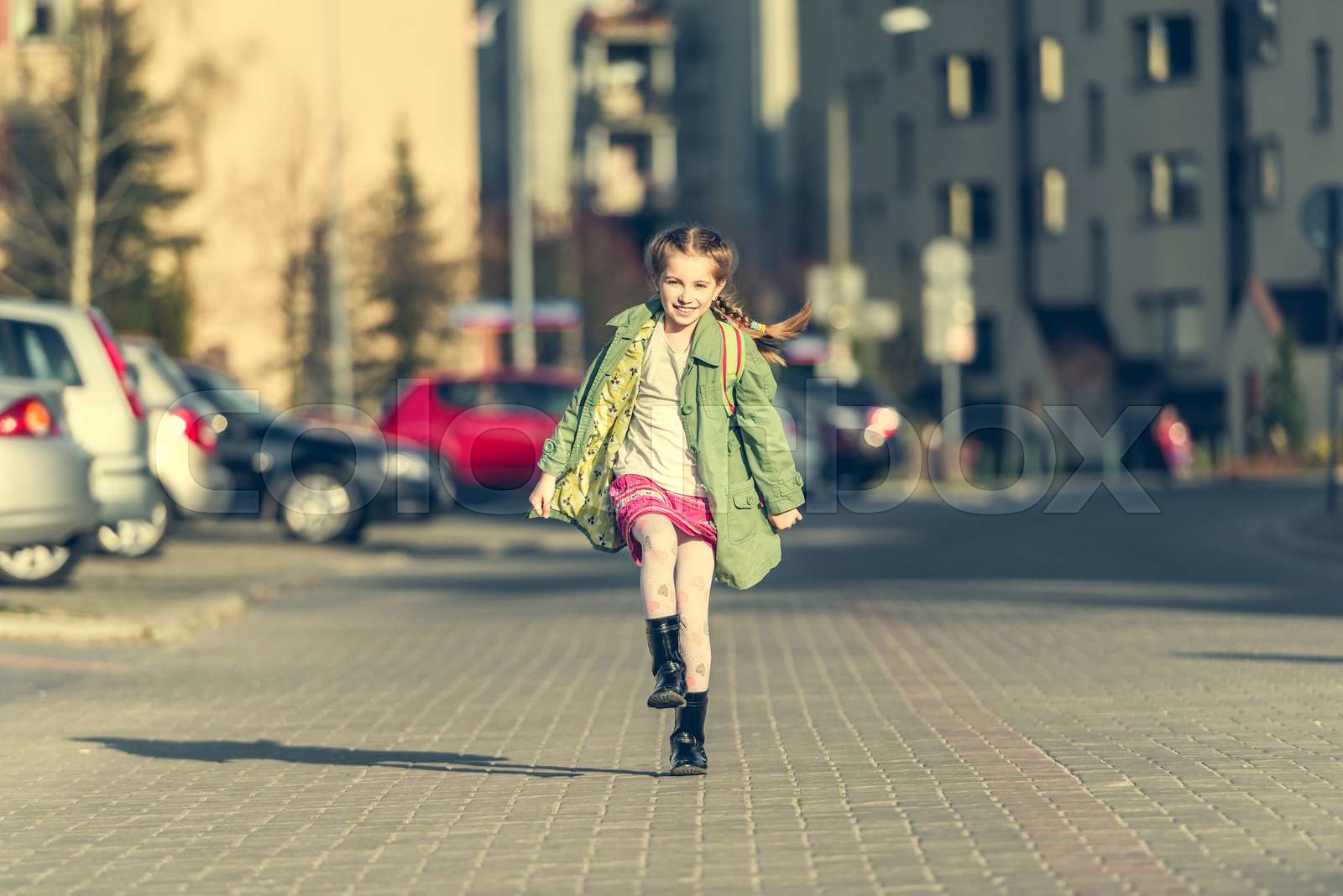 happy little girl running from school | Stock image | Colourbox