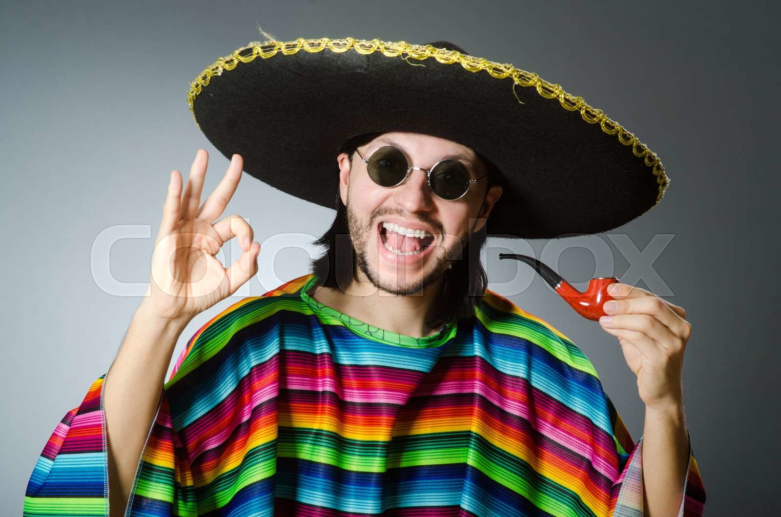 Mexican smoking pipe wearing sombrero | Stock image | Colourbox