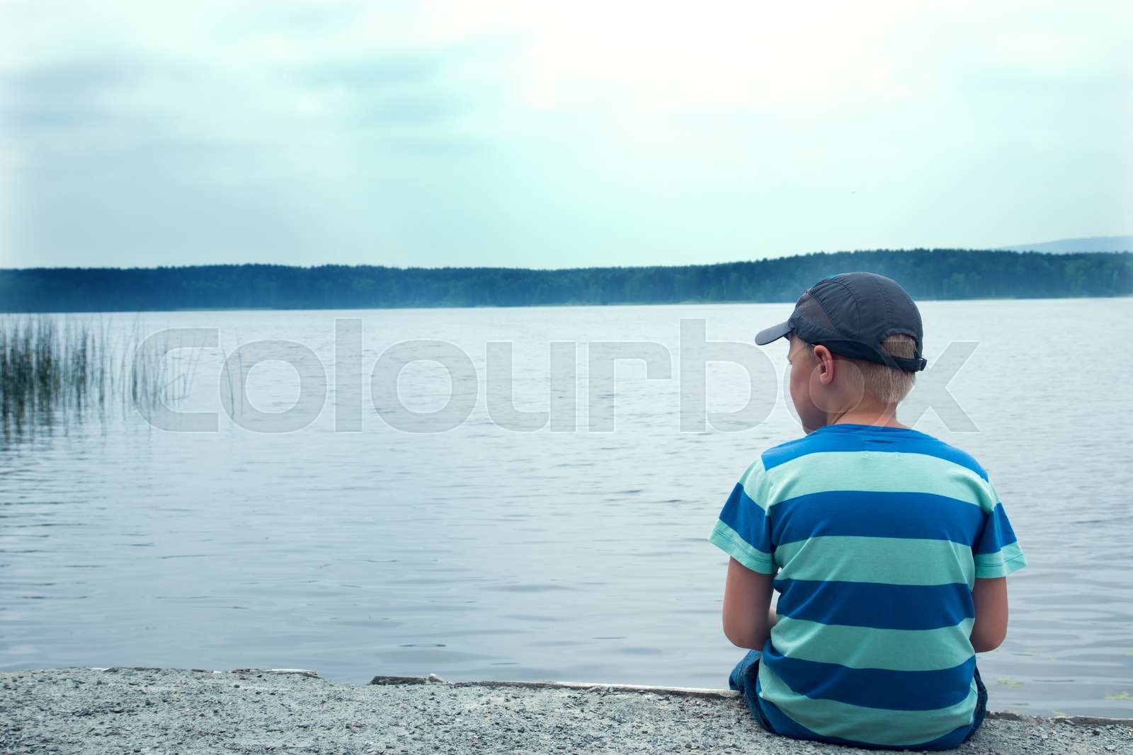 sad child sitting alone | Stock image | Colourbox