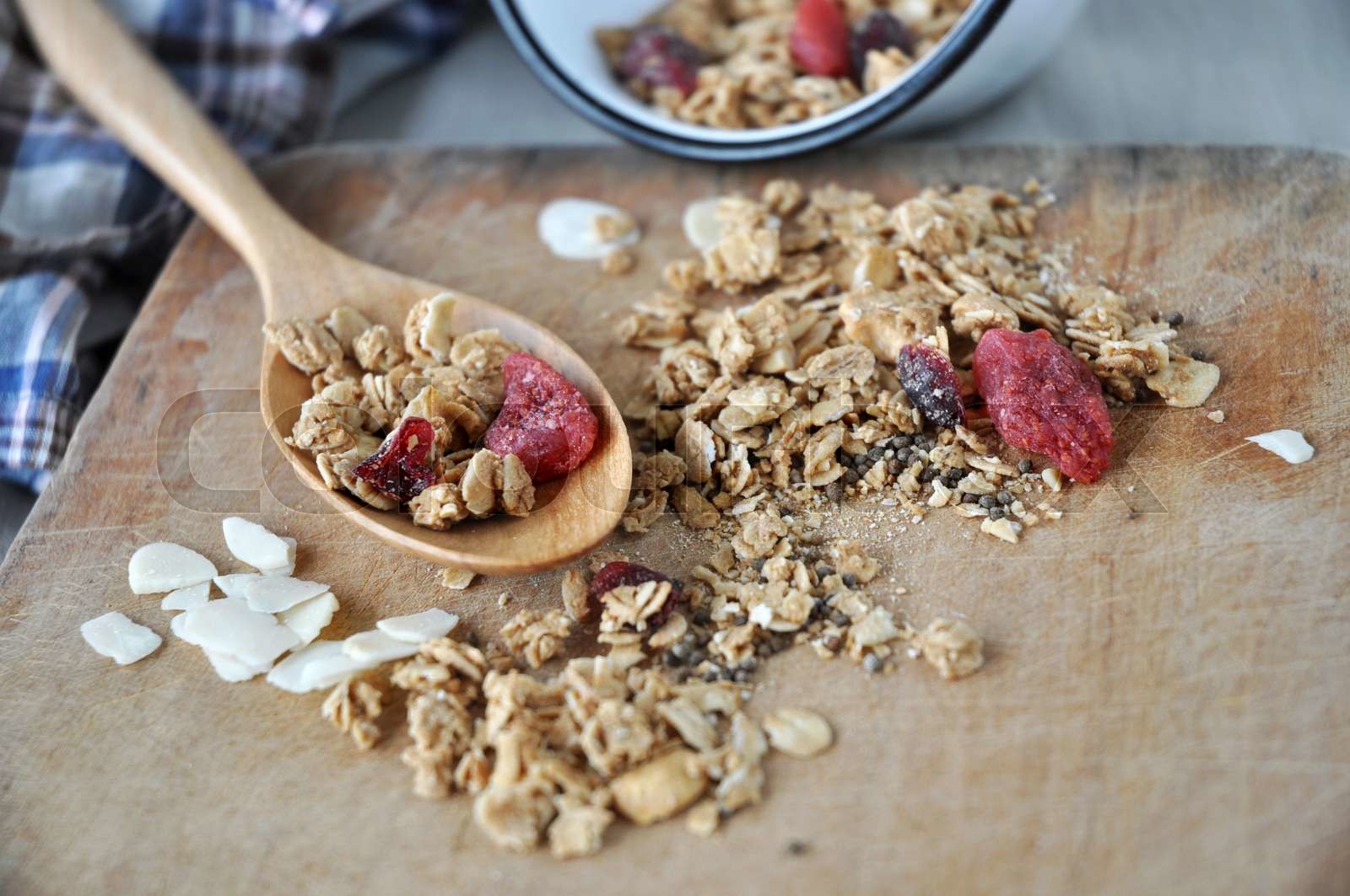 granola with dried berry spilling on board | Stock image | Colourbox