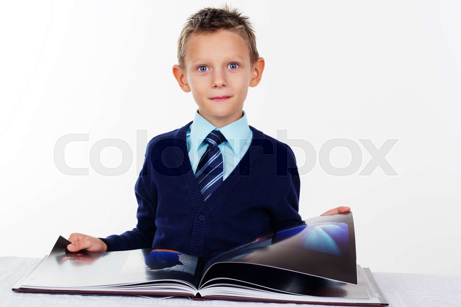 Little boy is reading a book, isolated on white | Stock image | Colourbox